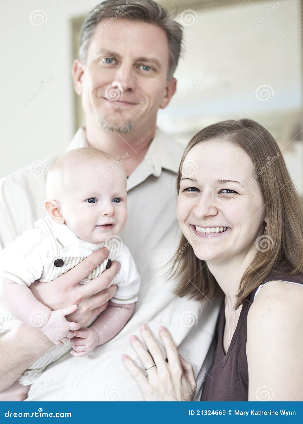 Happy parents holding baby stock image. Image of baby - 21324669