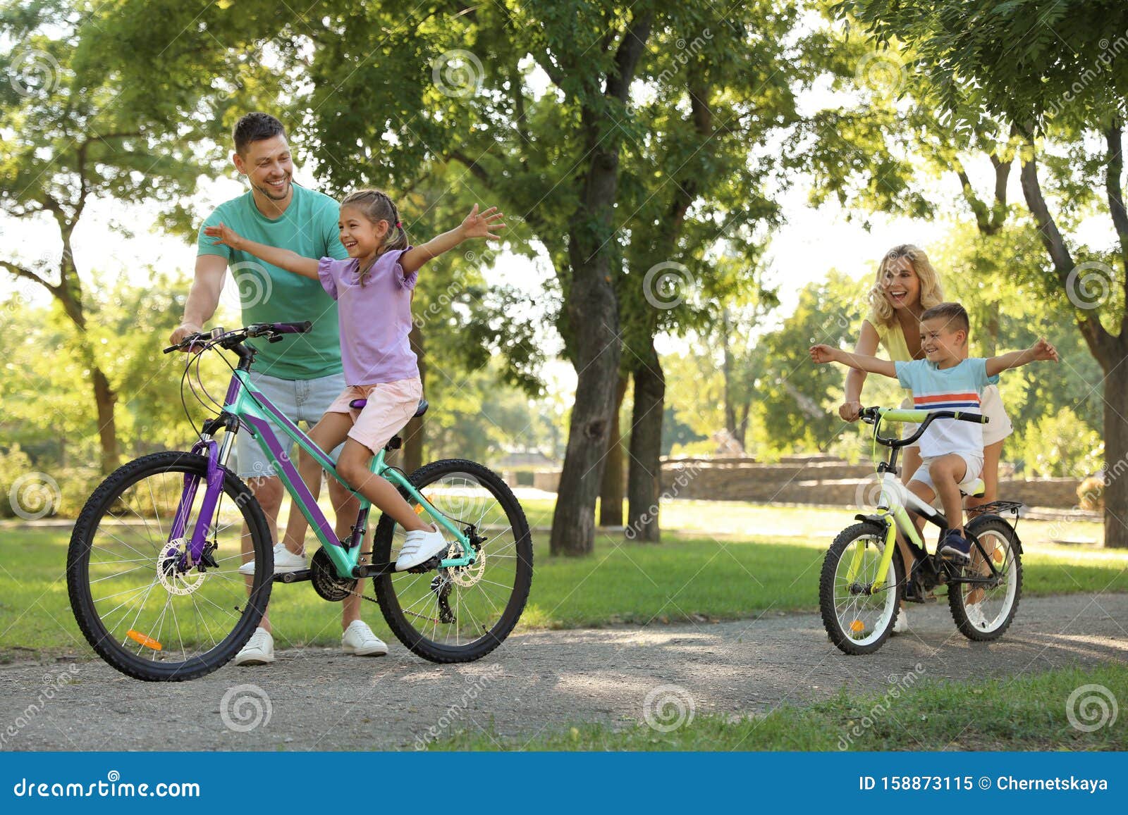 Happy Parents Teaching Their Children To Ride Bicycle Stock Image ... Happy Parents Teaching Their Children To Ride Bicycle Stock Image ...