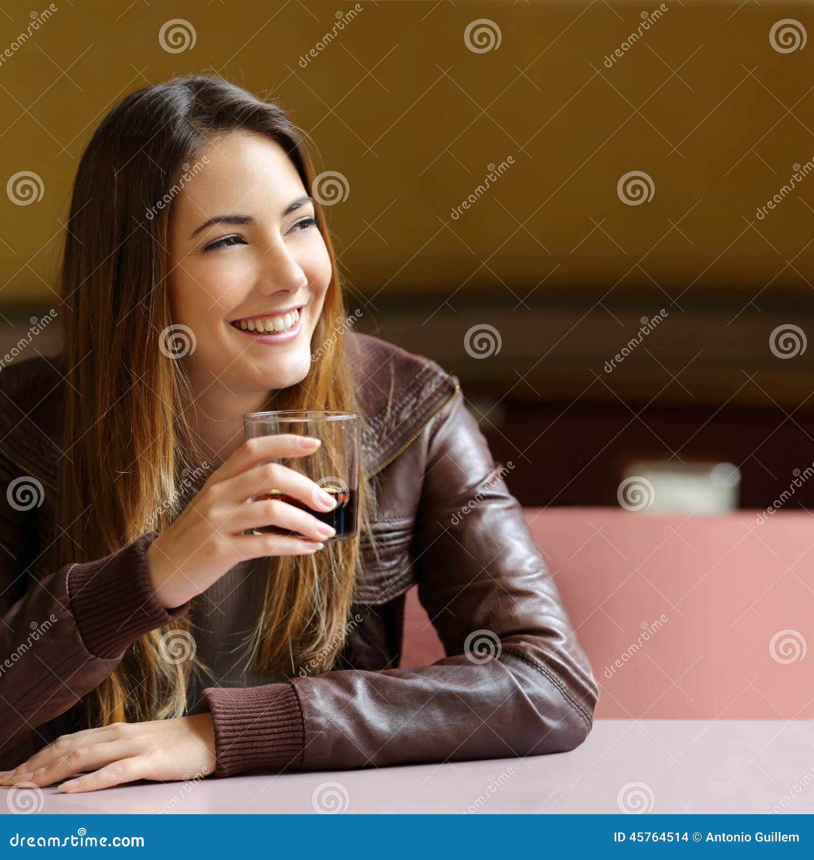 Happy Pensive Woman Refreshing with a Drink in a Restaurant Stock Photo ...