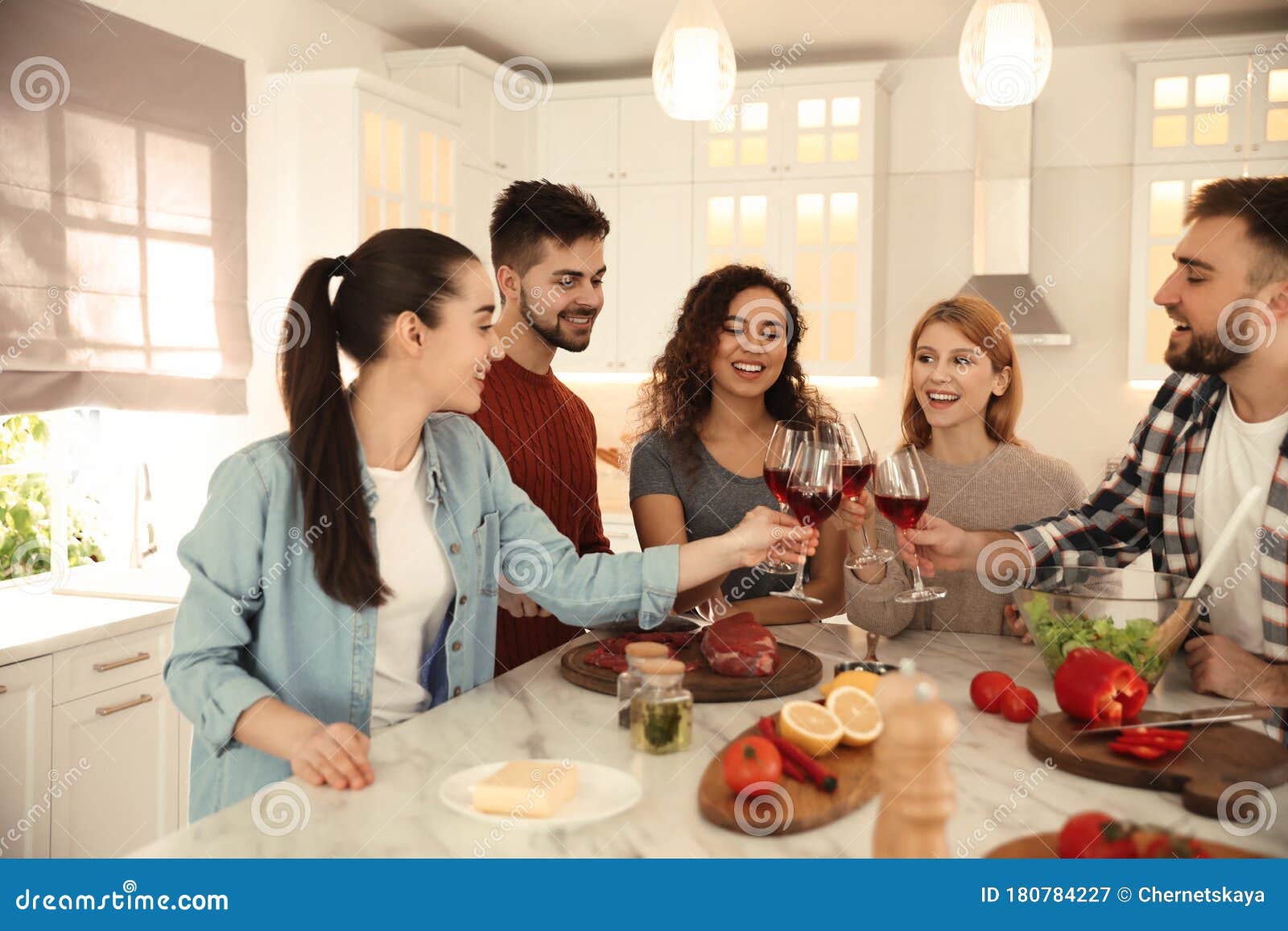 People Drinking Wine while Cooking Food in Kitchen Stock Image - Image ...