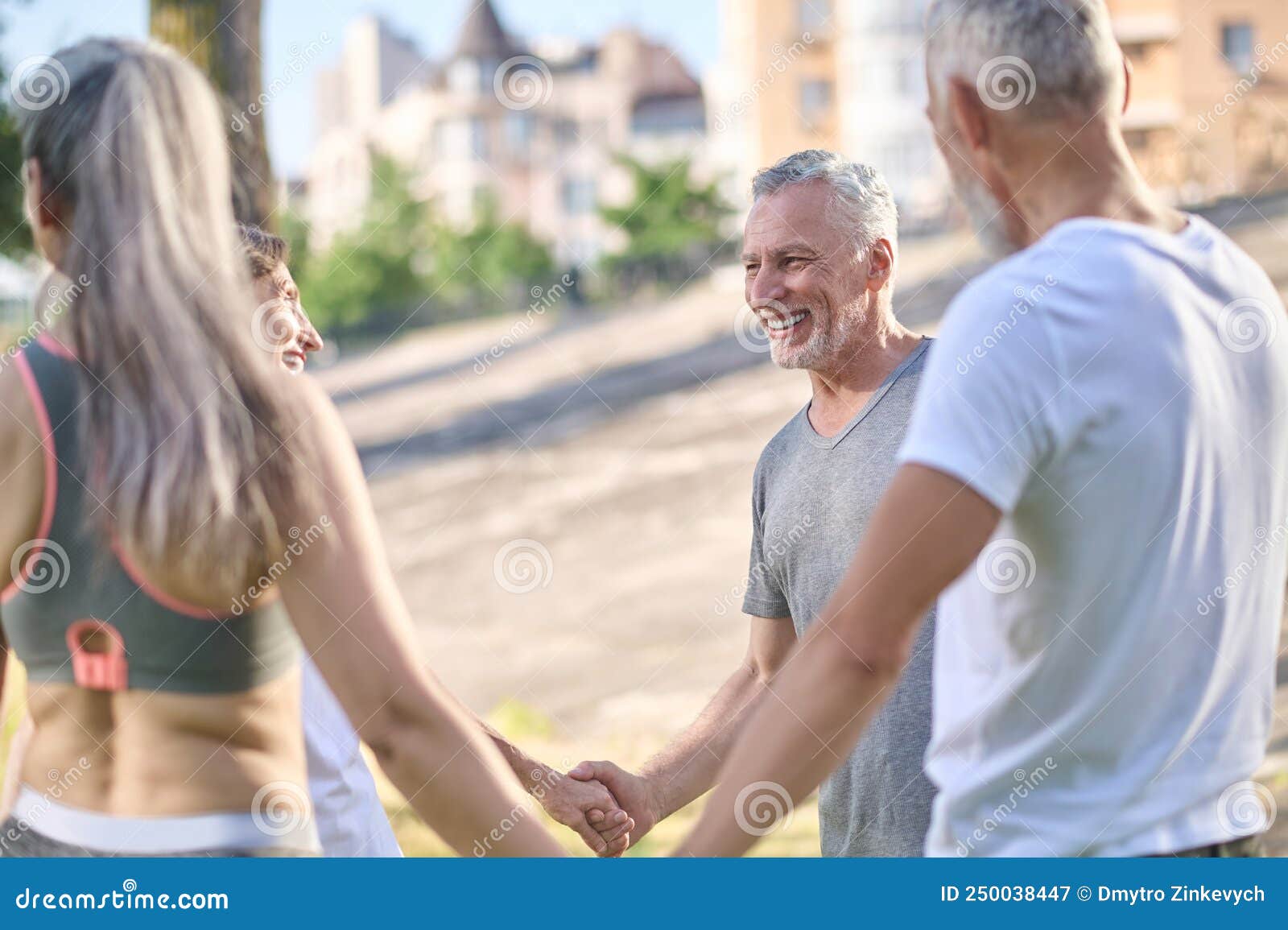 People Holding Hands and Looking Happy Stock Image - Image of maturity ...