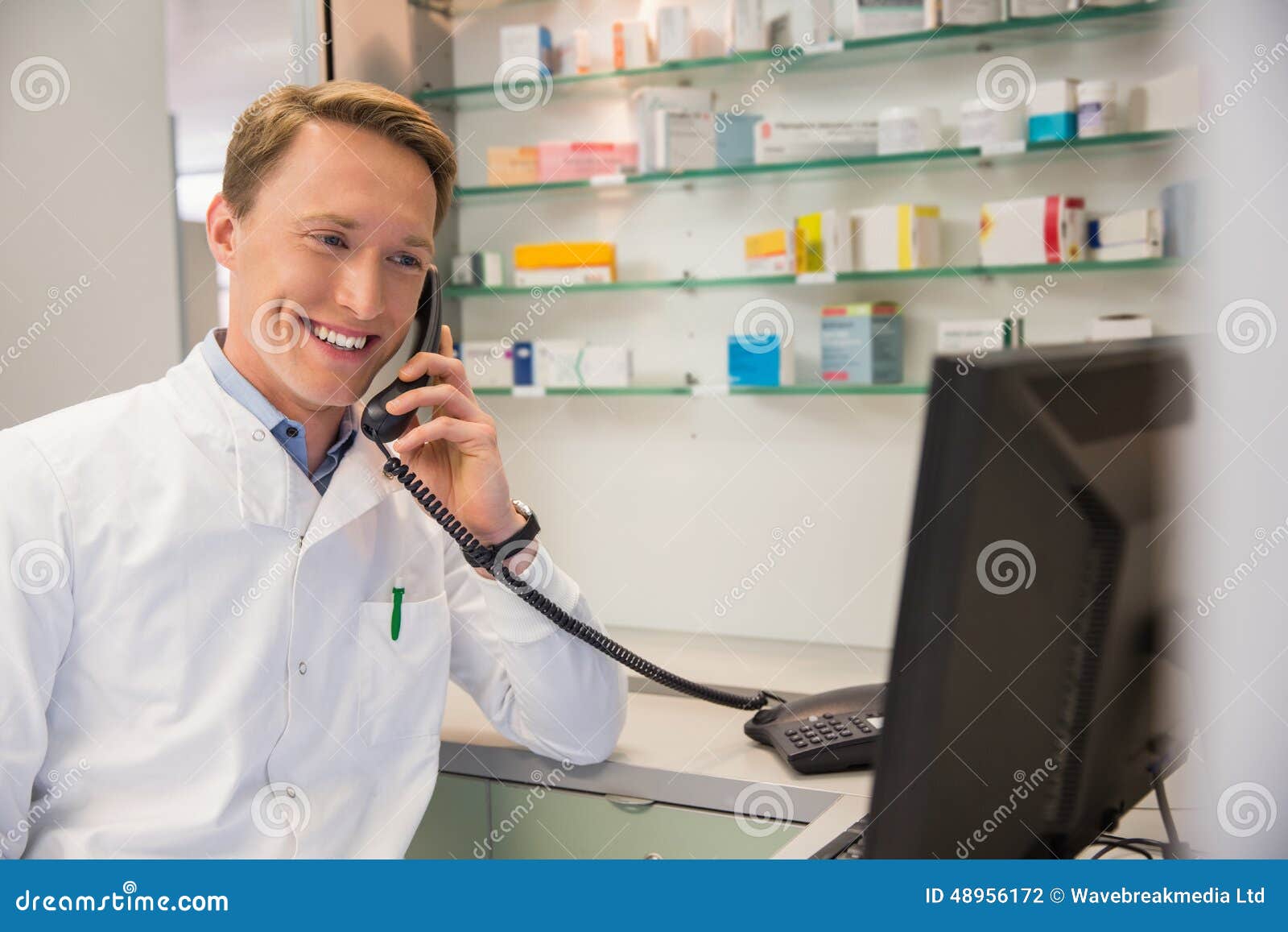 Happy Pharmacist on the Phone Using Computer Stock Photo - Image of ...