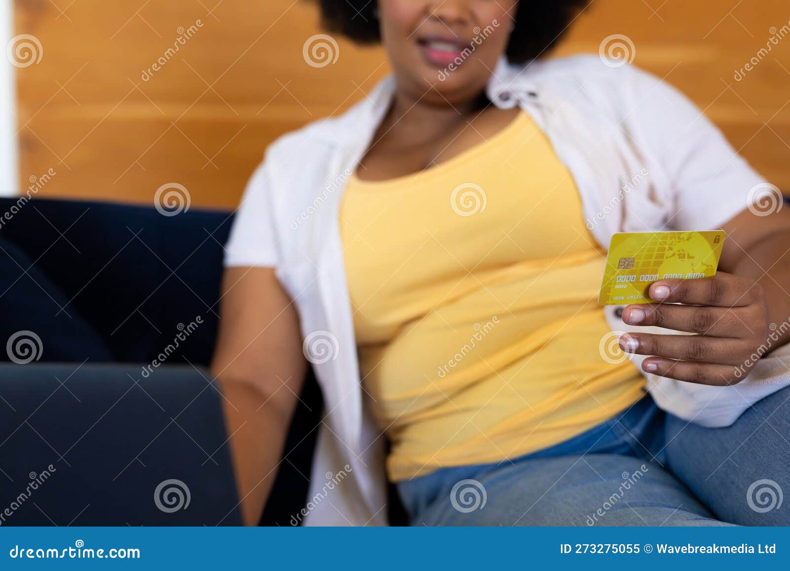 Happy Plus Size African American Woman On Sofa Online Shopping With