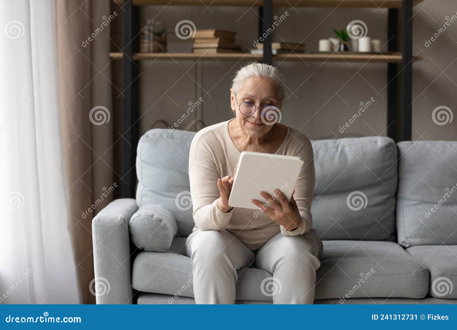 Happy Positive Elder Lady Browsing Internet on Tablet Computer Stock ...