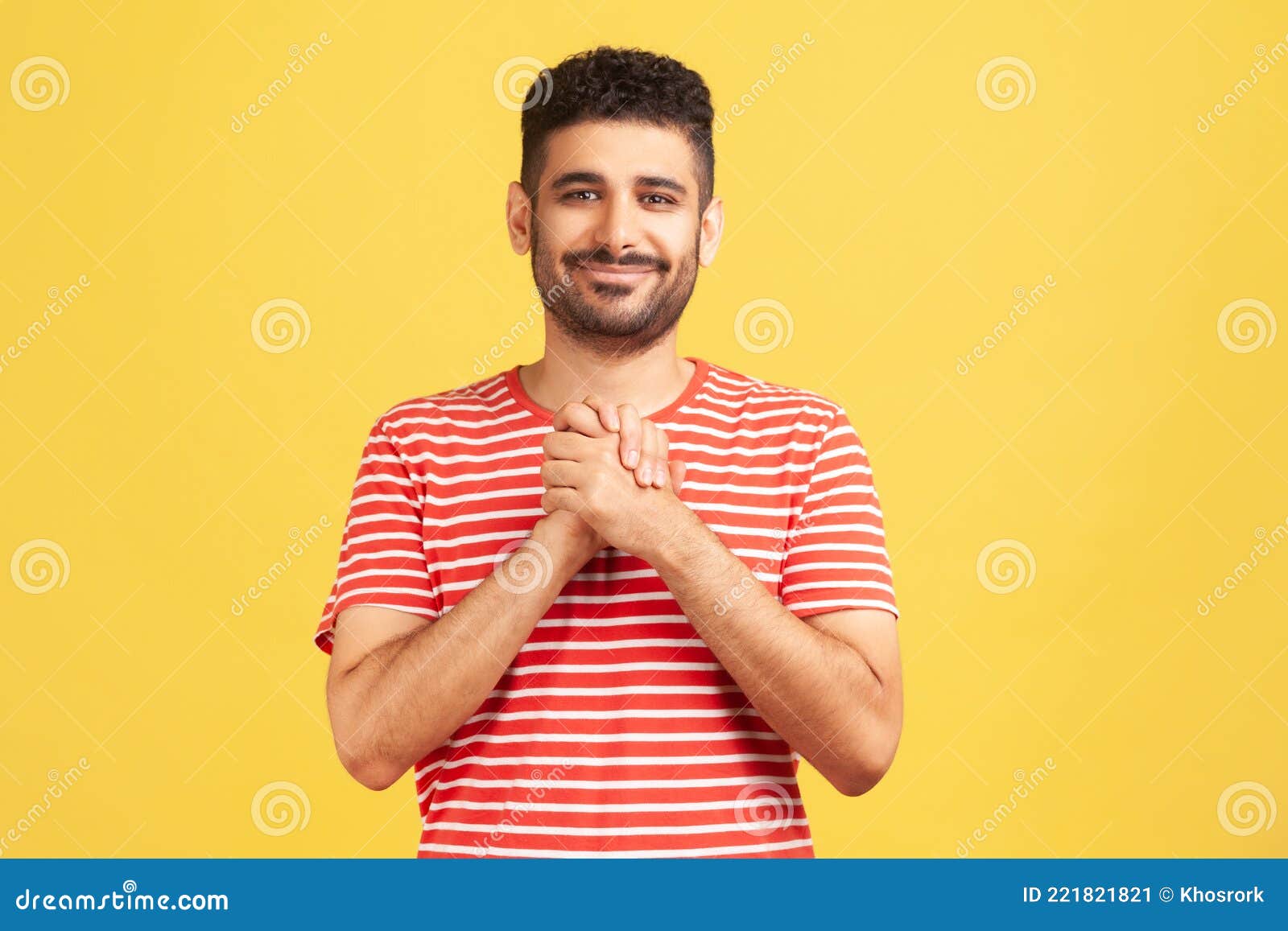 Happy Positive Man With Beard In Striped Shirt Pressing Hands Together