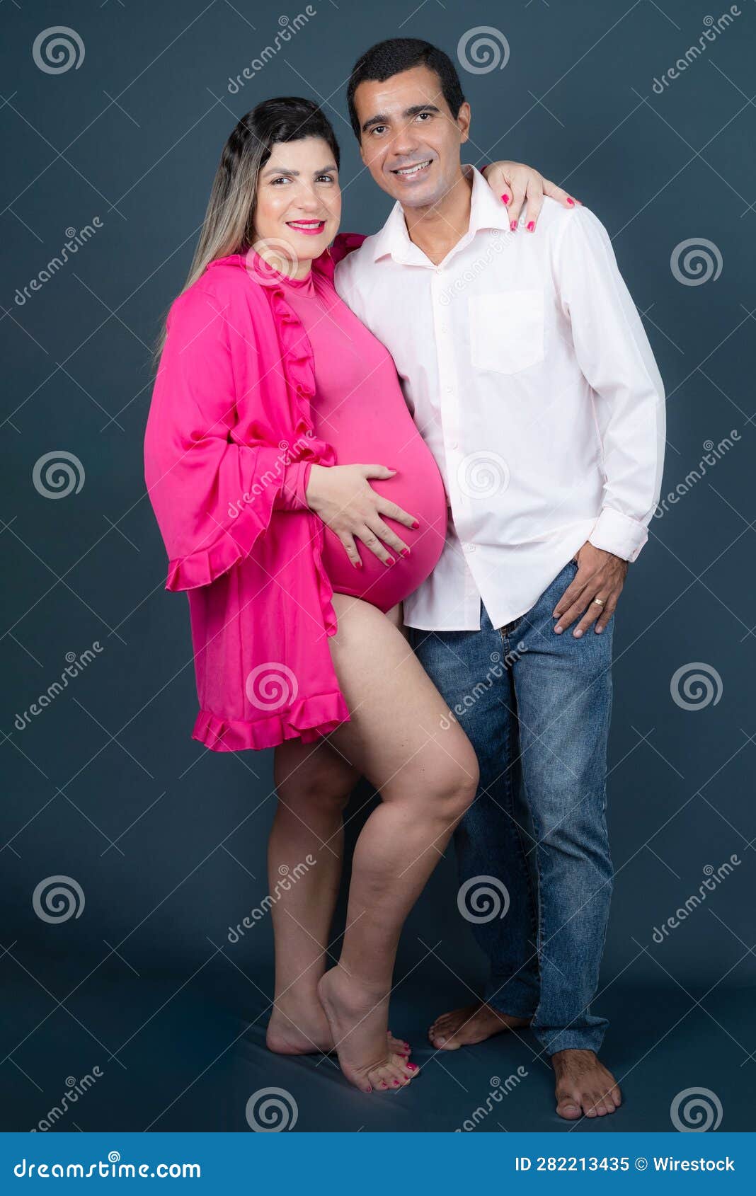 Happy Pregnant Caucasian Woman Posing With Her Loving Husband For A