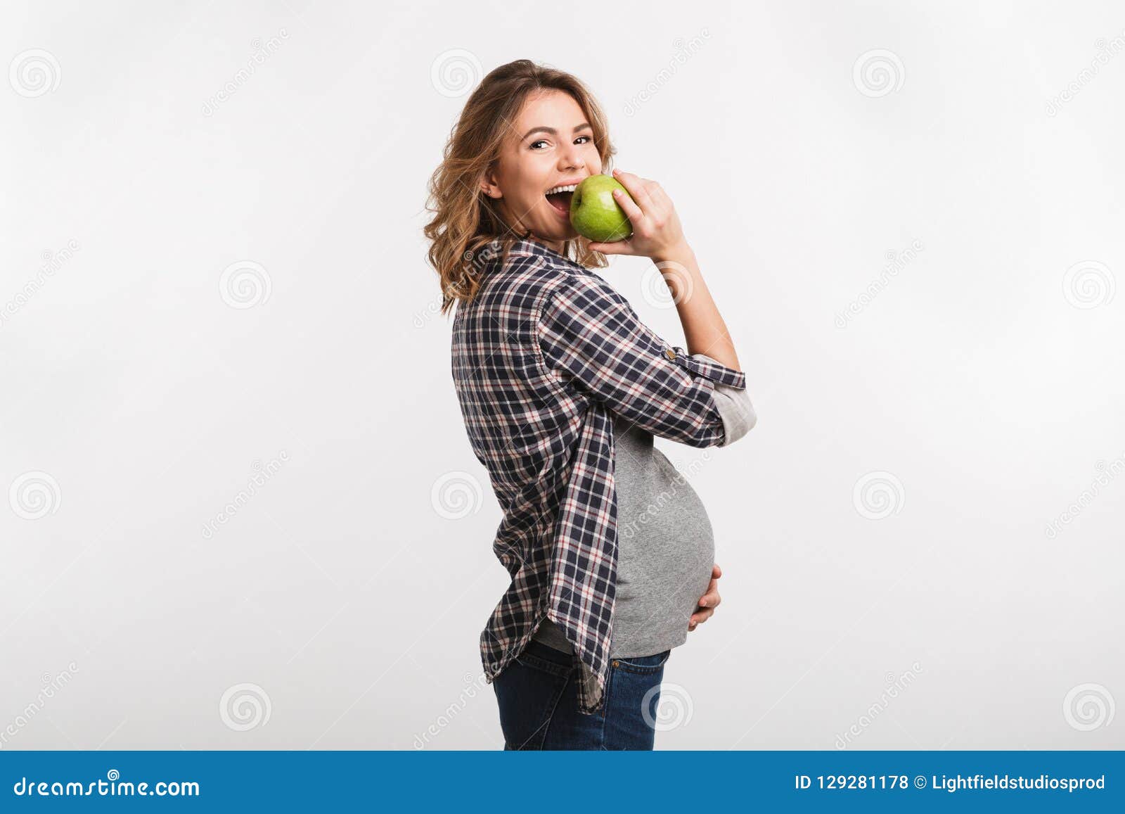 Happy Pregnant Woman Eating Apple and Smiling at Camera Stock Photo ... Happy Pregnant Woman Eating Apple and Smiling at Camera Stock Photo ...