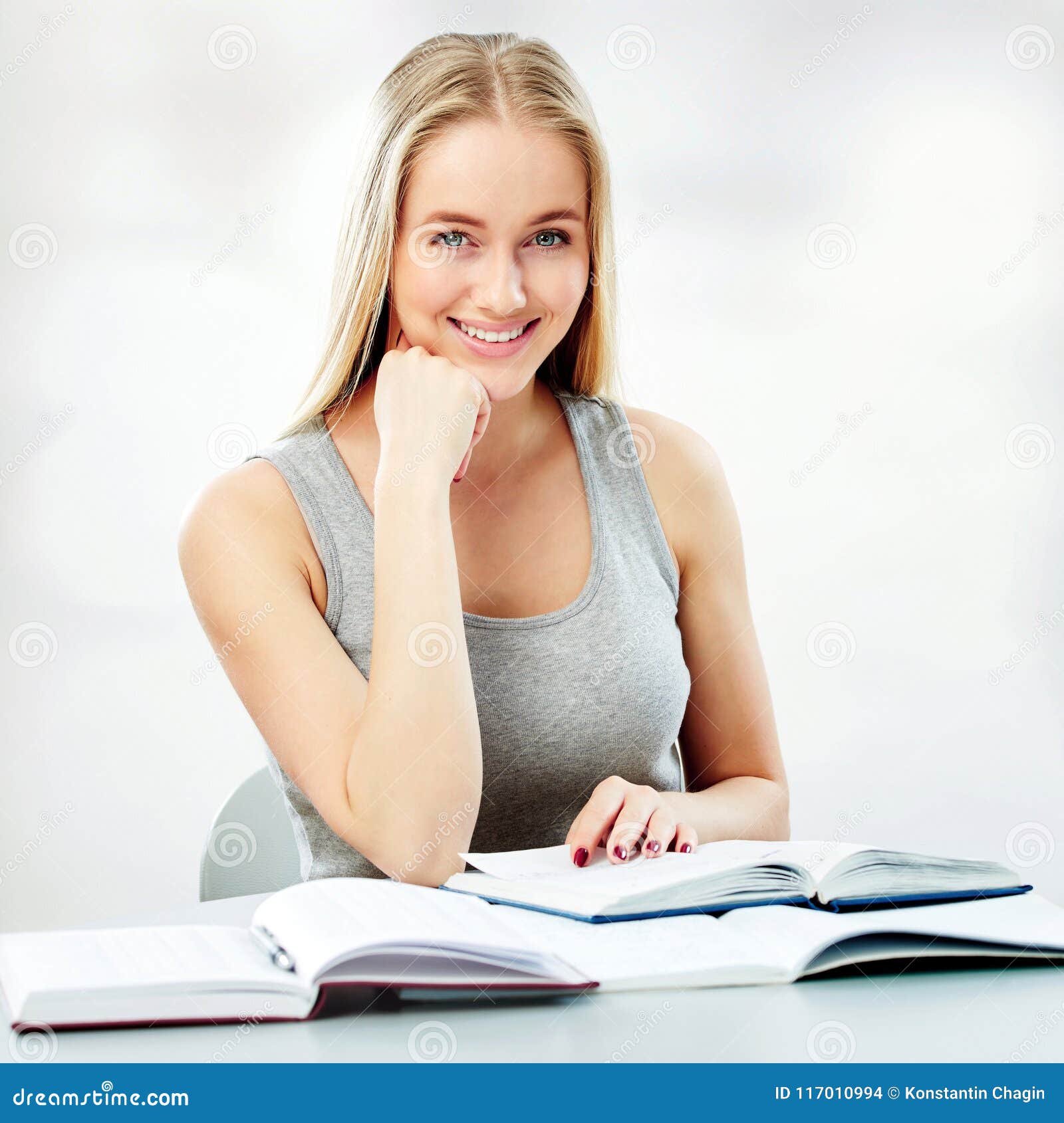 Pretty woman with books stock photo. Image of indoors - 117010994