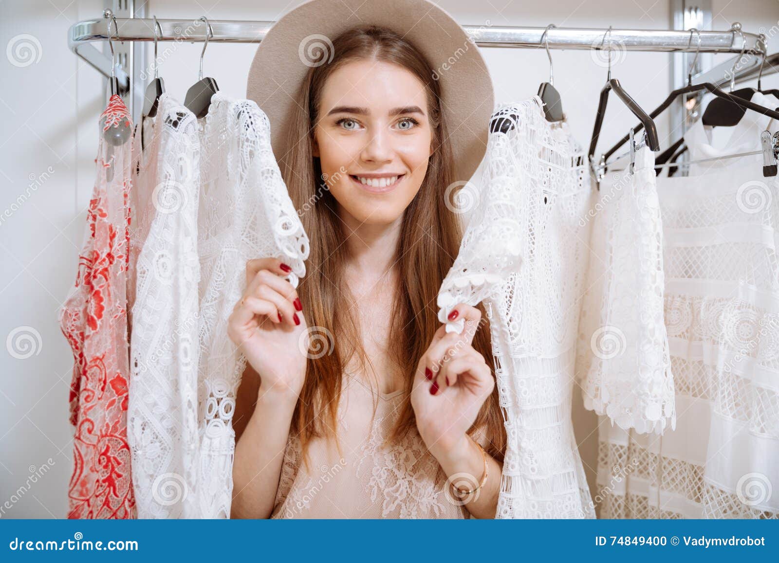 Happy Pretty Young Woman Choosing Clothes in Clothing Store Stock Photo ... Happy Pretty Young Woman Choosing Clothes in Clothing Store Stock Photo ...