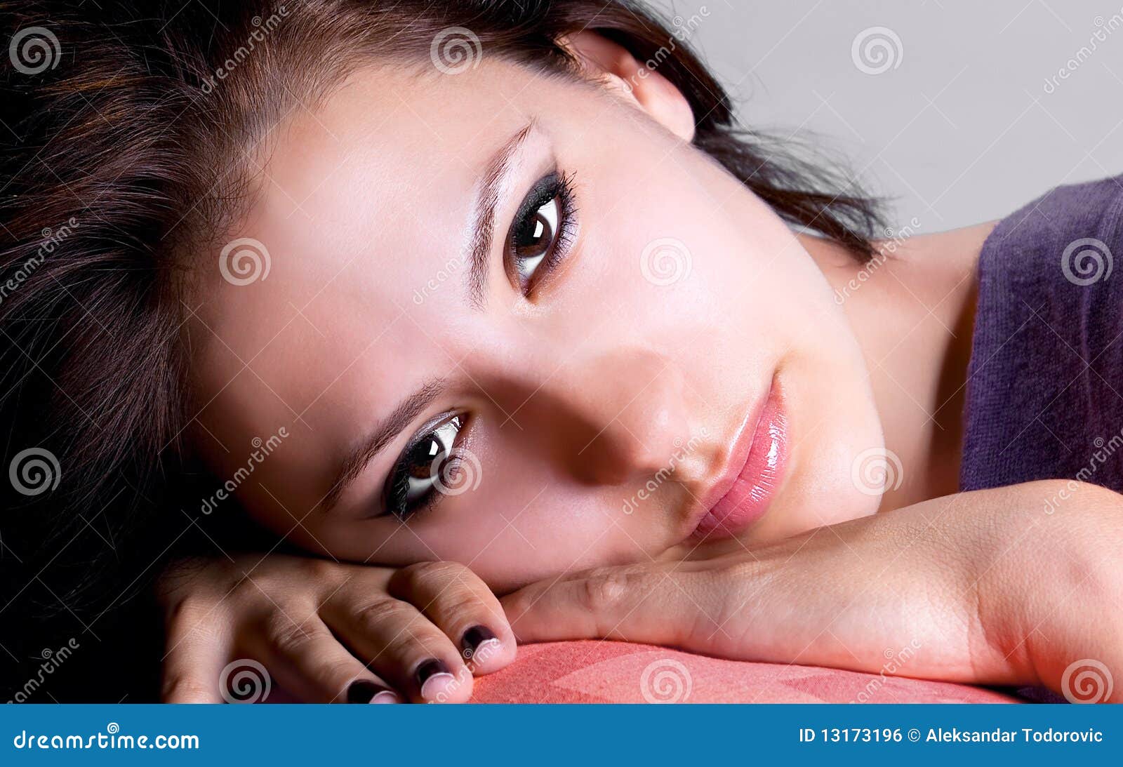 Happy Pretty Young Woman with Hands at Face Lying Stock Photo - Image ...