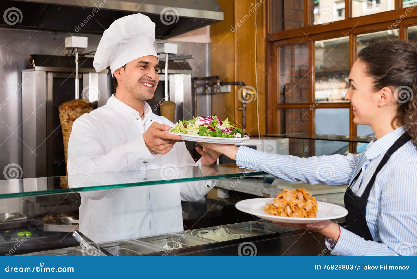 Happy Professional Chef and Young Waitress Taking Kebab for Cli Stock ...