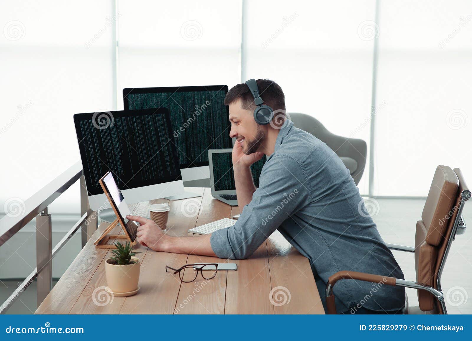 Happy Programmer with Headphones Working at Desk Stock Image - Image of ...
