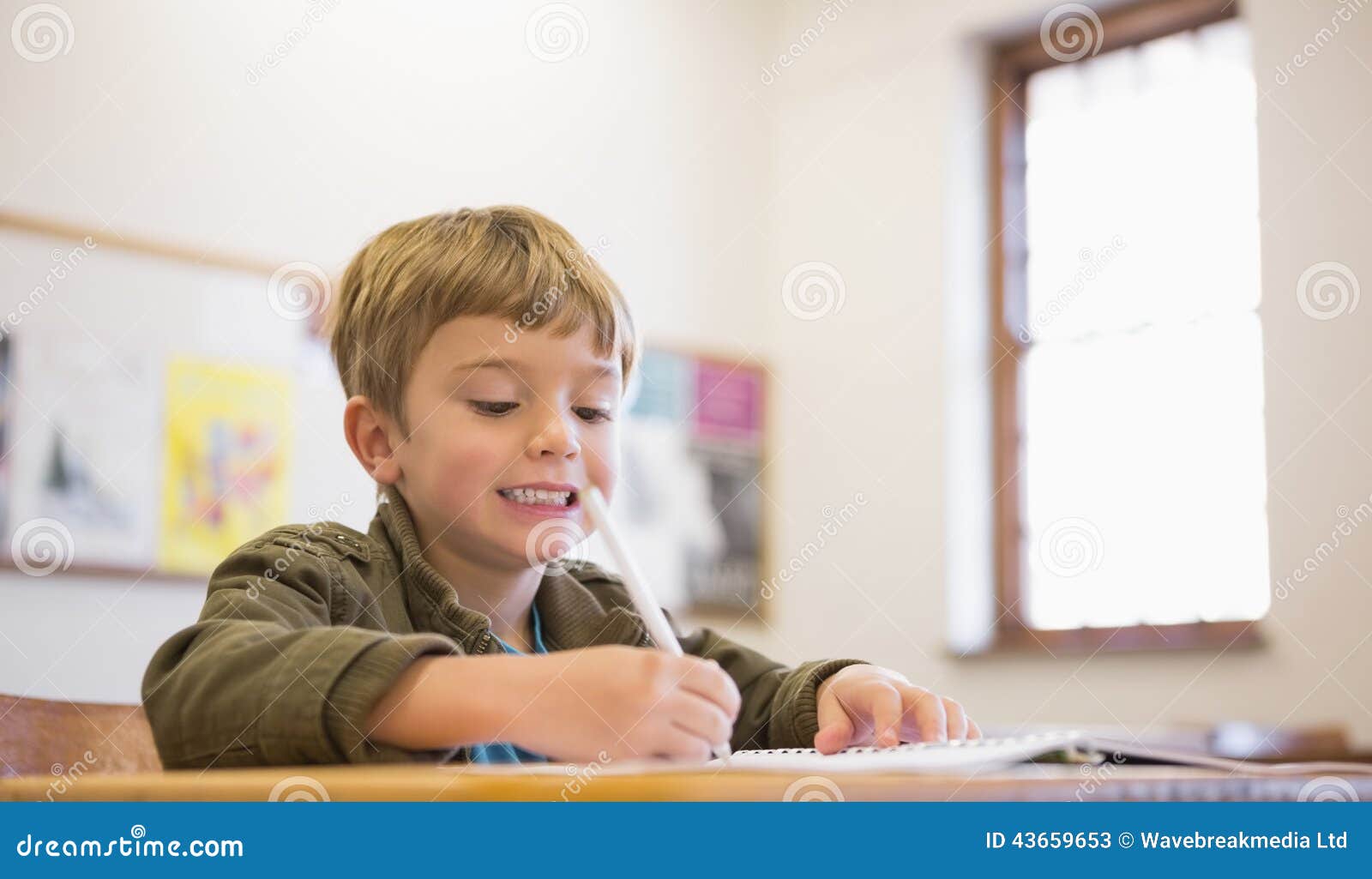 Happy Pupil Writing in Notepad at His Desk Stock Image - Image of ...