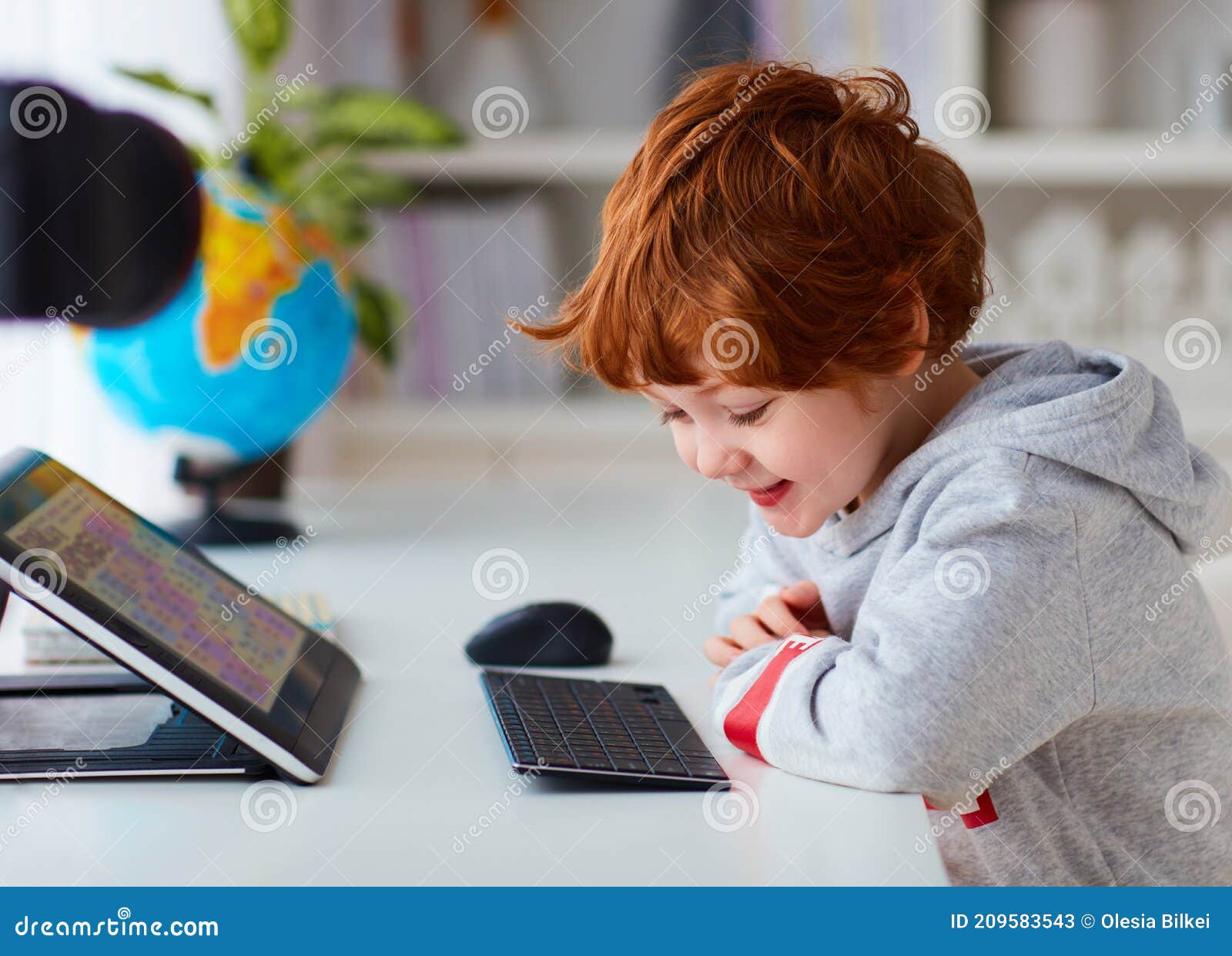 Happy Redhead Kid Typing on Keyboard, Studying on Laptop at Home Stock ...