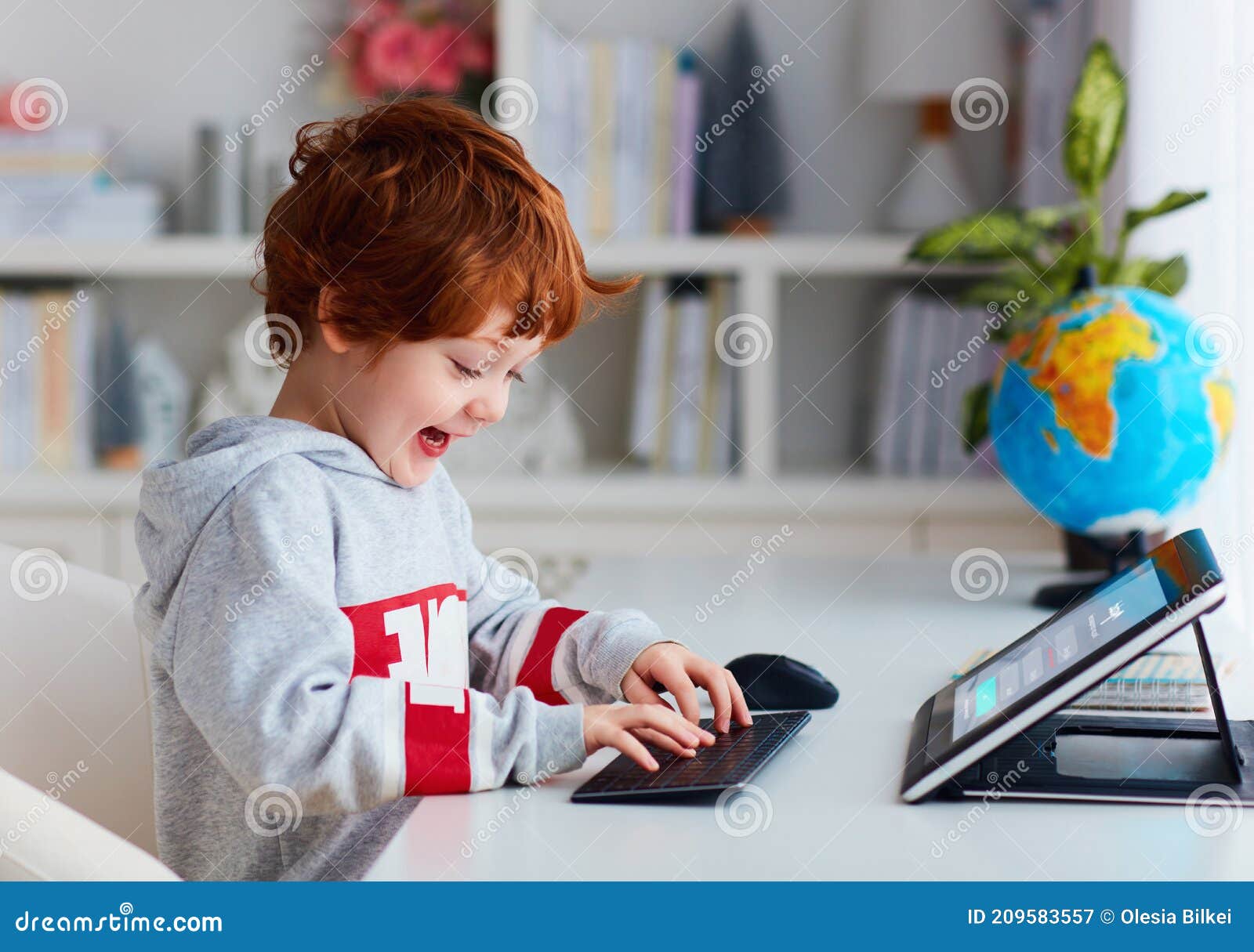 Happy Redhead Kid Typing on Keyboard, Studying on Laptop at Home Stock ...