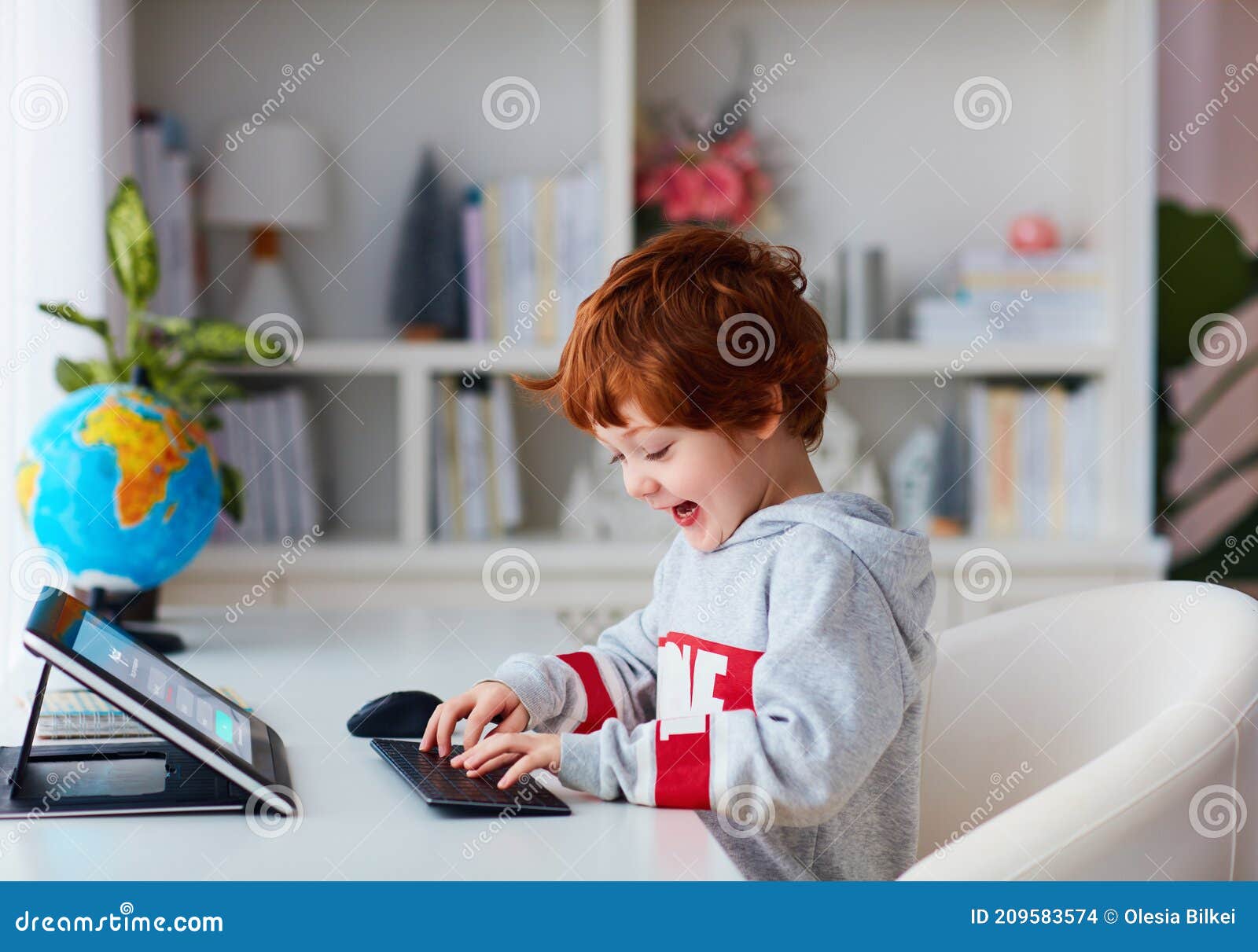 Happy Redhead Kid Typing on Keyboard, Studying on Laptop at Home Stock ...