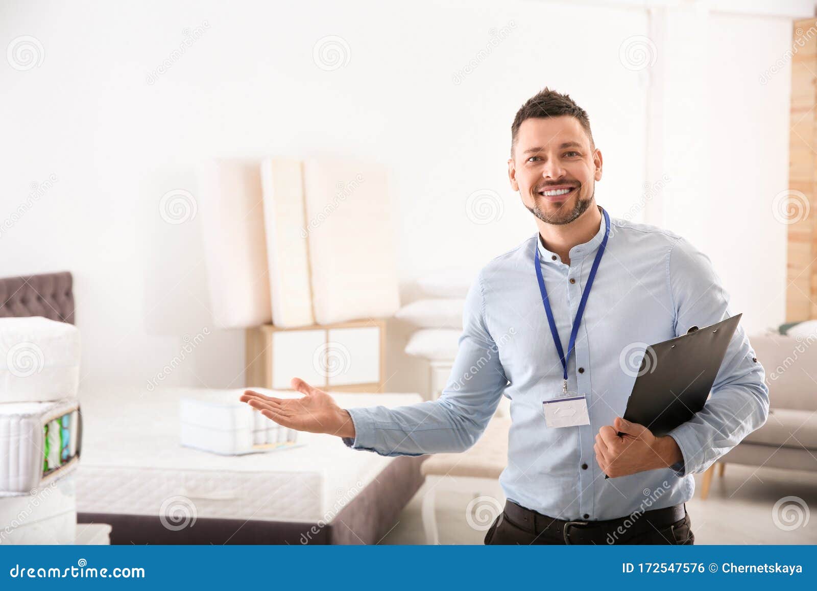 Happy Salesman with Clipboard in Store. Space for Text Stock Photo ...
