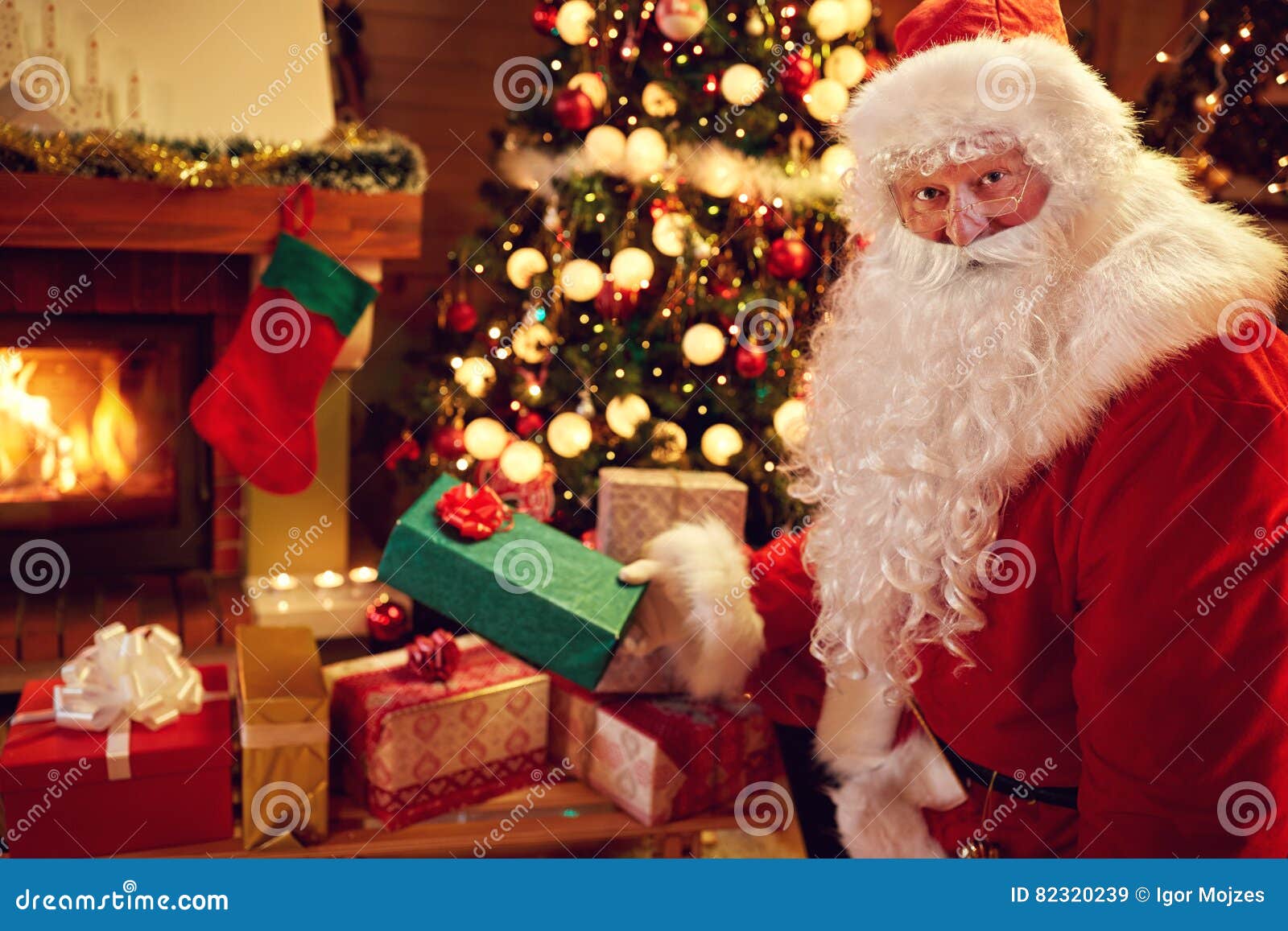 Happy Santa with Christmas Present Stock Image - Image of bokeh, noel ...