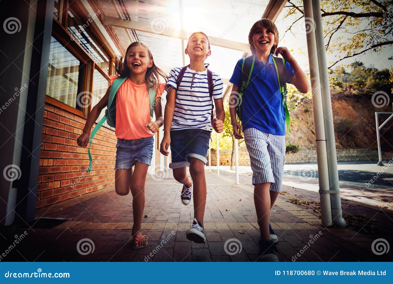 Happy School Kids Running in Corridor Stock Photo - Image of front ...