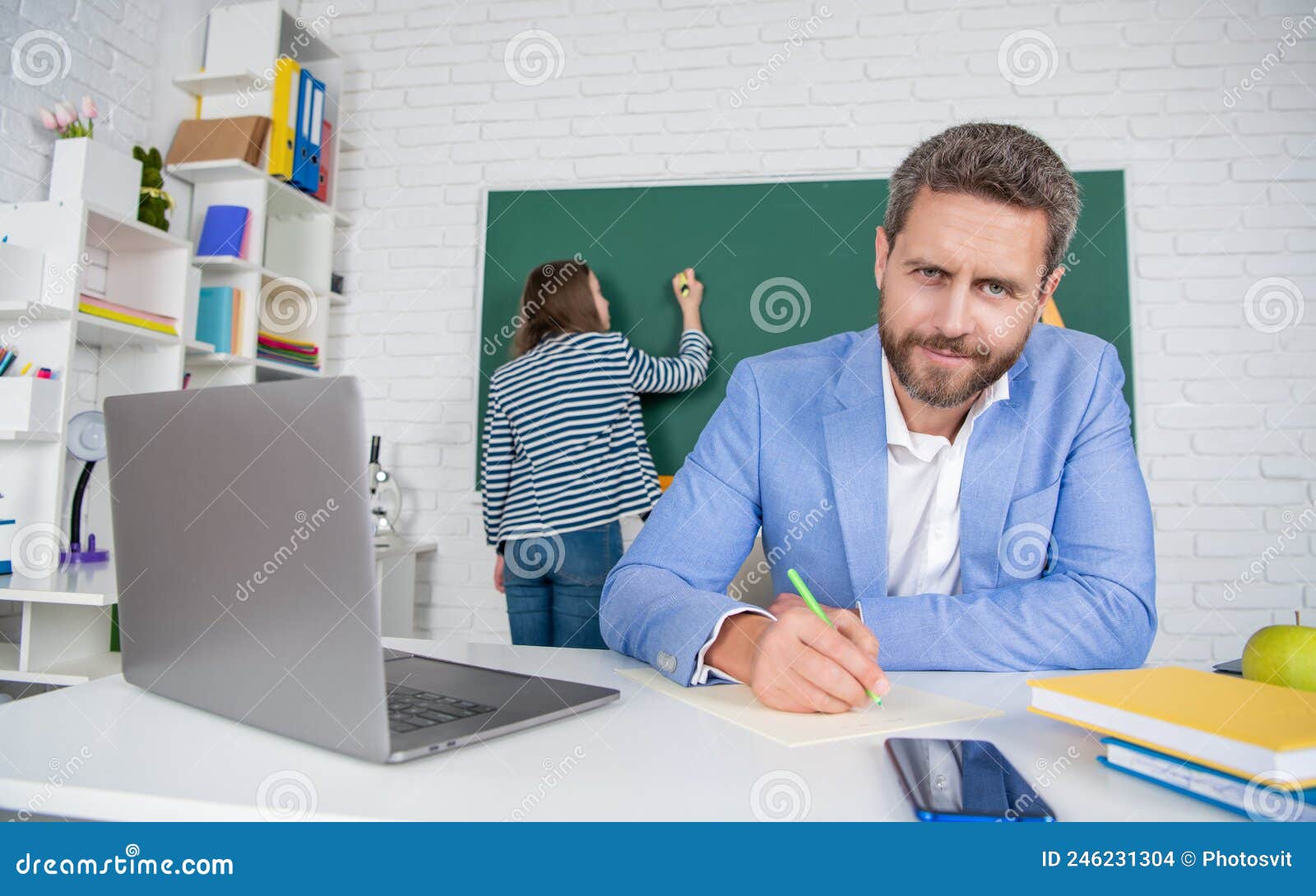 Happy School Teacher in Classroom with Selective Focus of Kid at ...