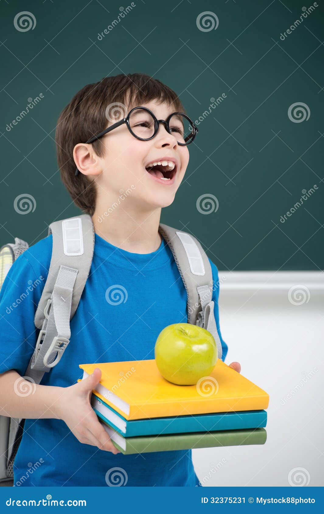 Happy Schoolboy. Happy Little Schoolboy Holding the Book Stack a Stock ...