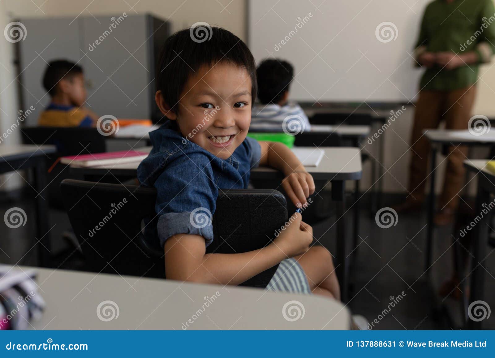Happy Schoolboy Looking Back in Classroom Stock Image - Image of ...