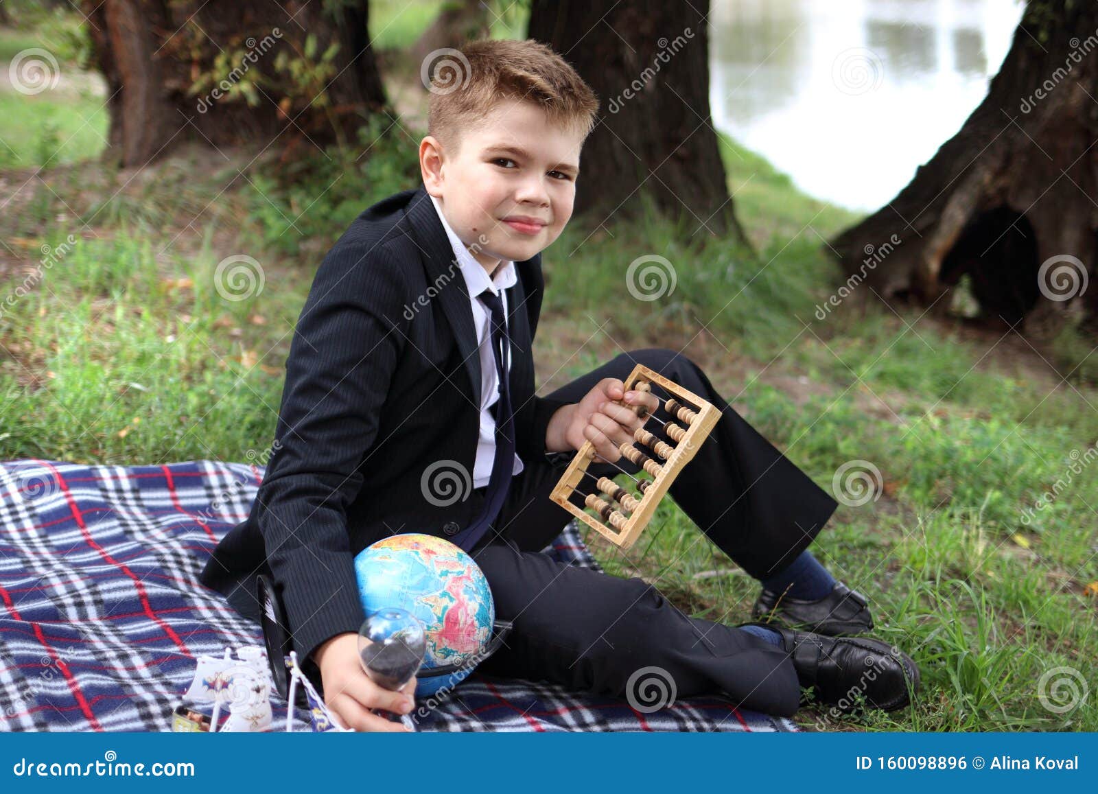 A Schoolboy in Nature in a Black Suit Rests after School Stock Photo ...