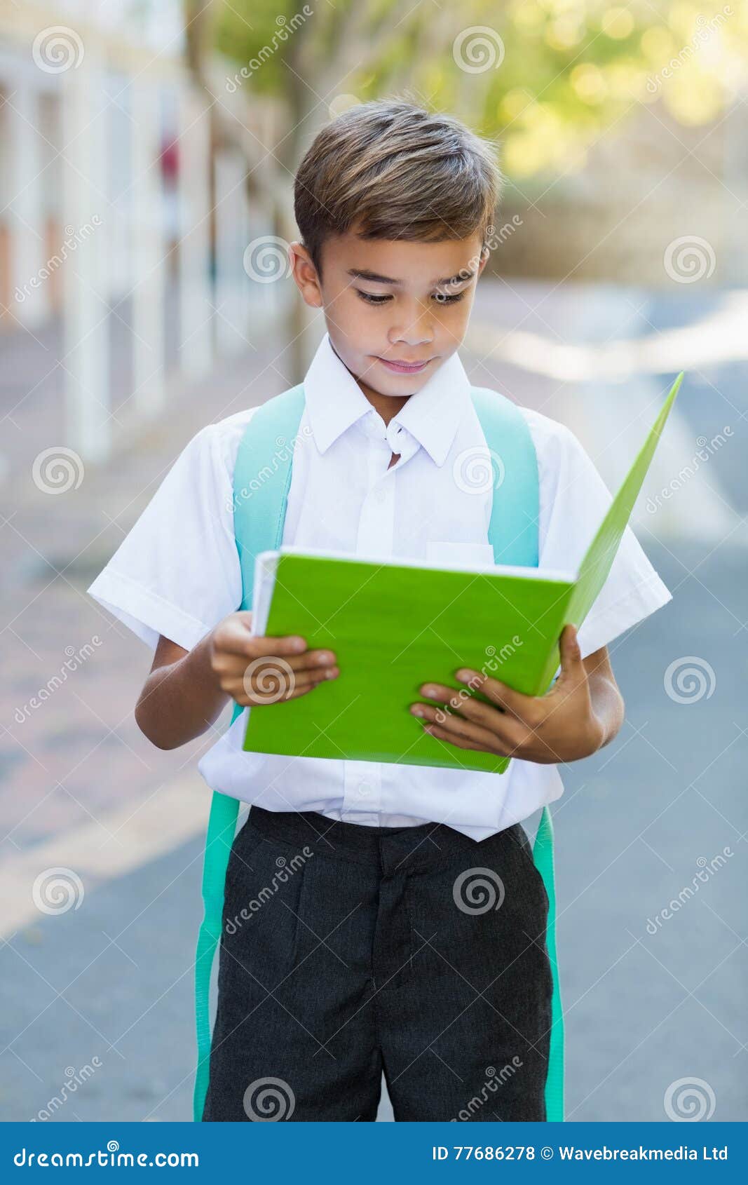 Happy Schoolboy Reading Book in Campus Stock Photo - Image of outdoors ...