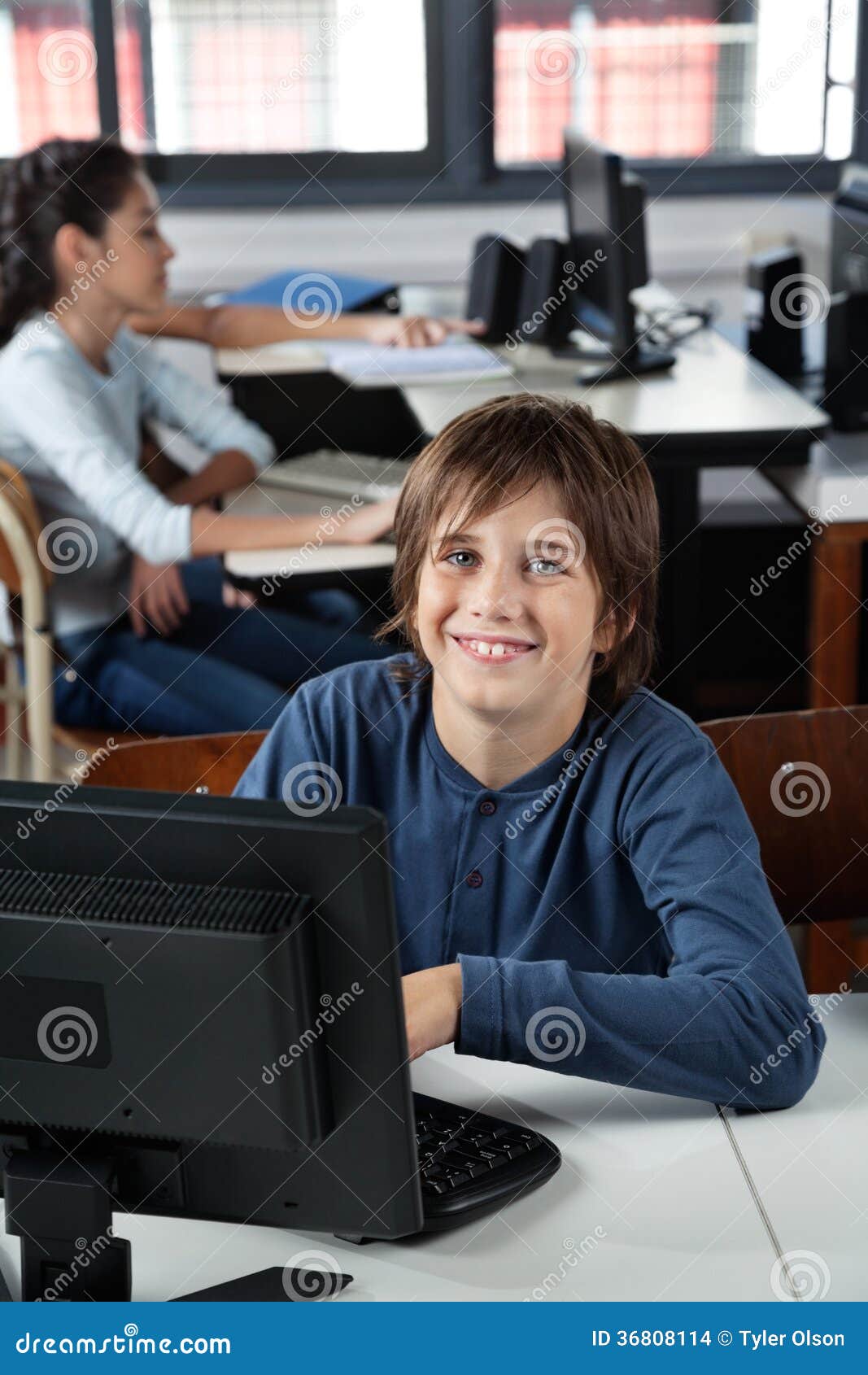 Happy Schoolboy Sitting with Computer at Desk Stock Photo - Image of ...
