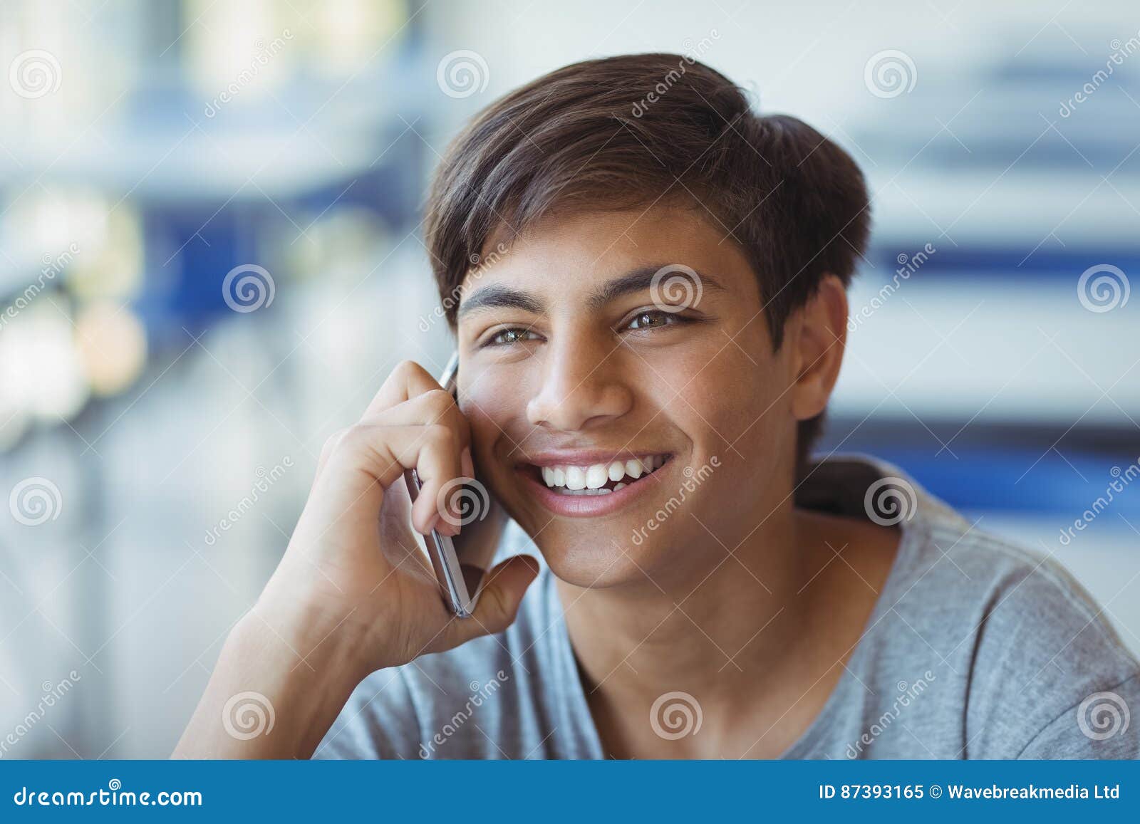 Happy Schoolboy Talking on Mobile Phone in Classroom Stock Image ...