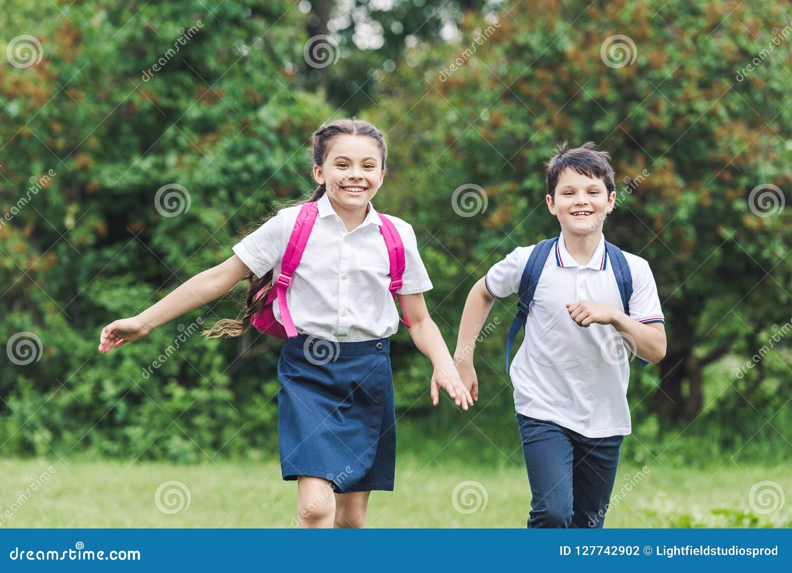 Happy Schoolchildren with Backpacks Running Stock Photo - Image of ...
