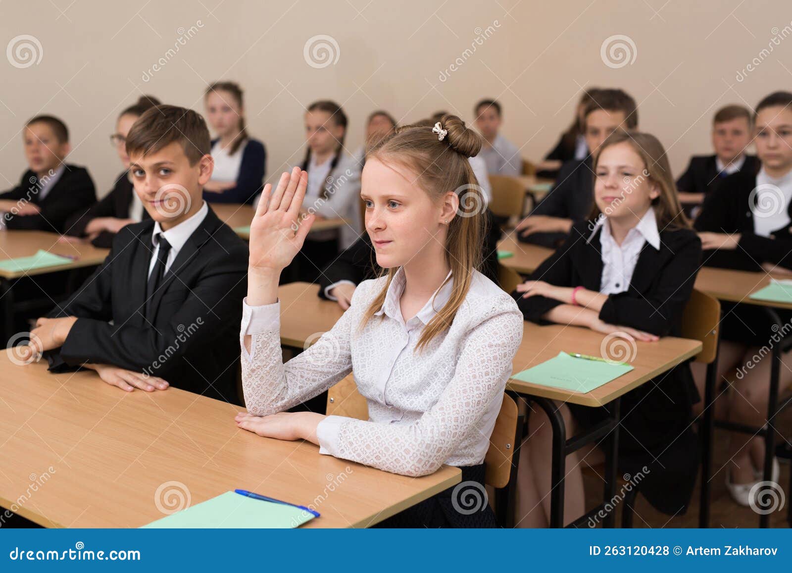 Happy Schoolchildren Sit at a Desk in the Classroom. Stock Photo ...