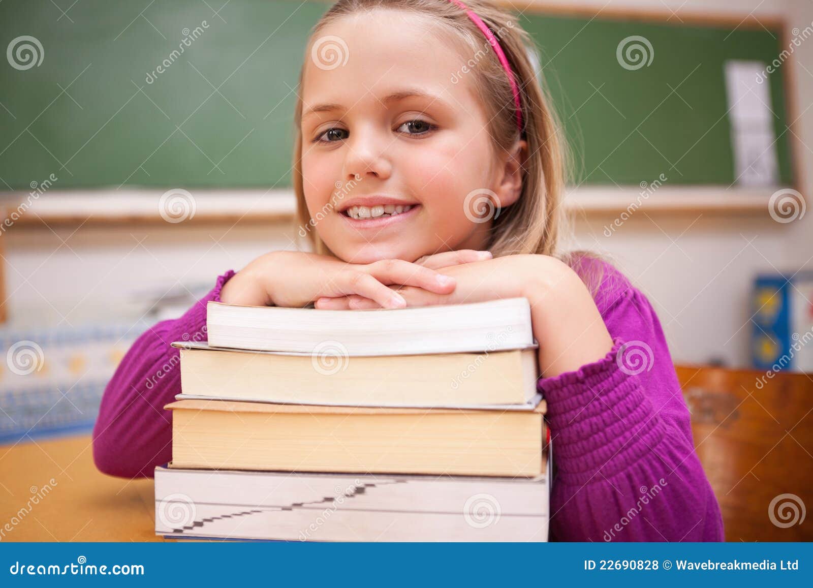 Happy Schoolgirl Posing with a Stack of Books Stock Photo - Image of ...
