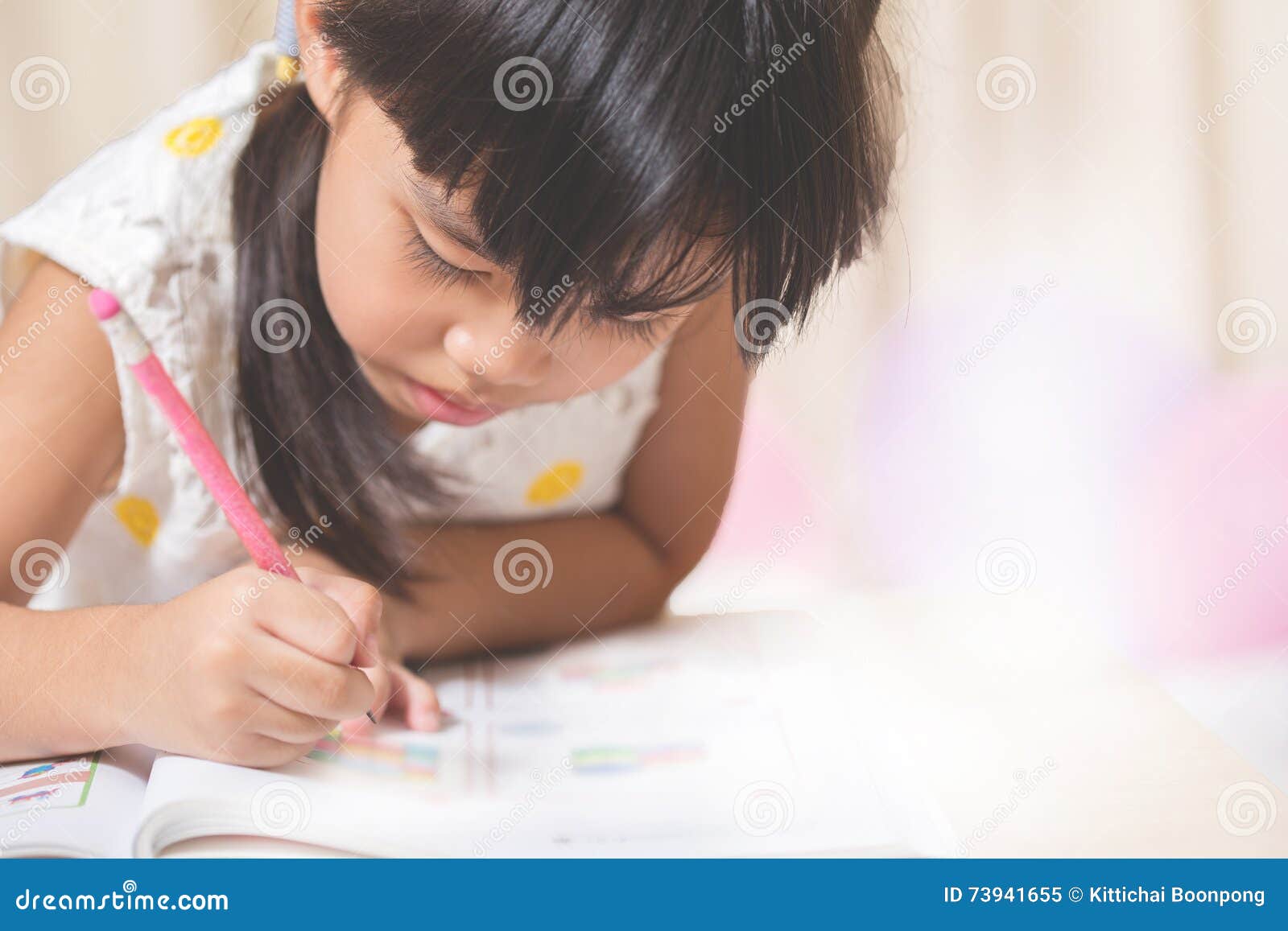 Happy Schoolgirl Works on Her Homework, Write Something in Her N Stock ...