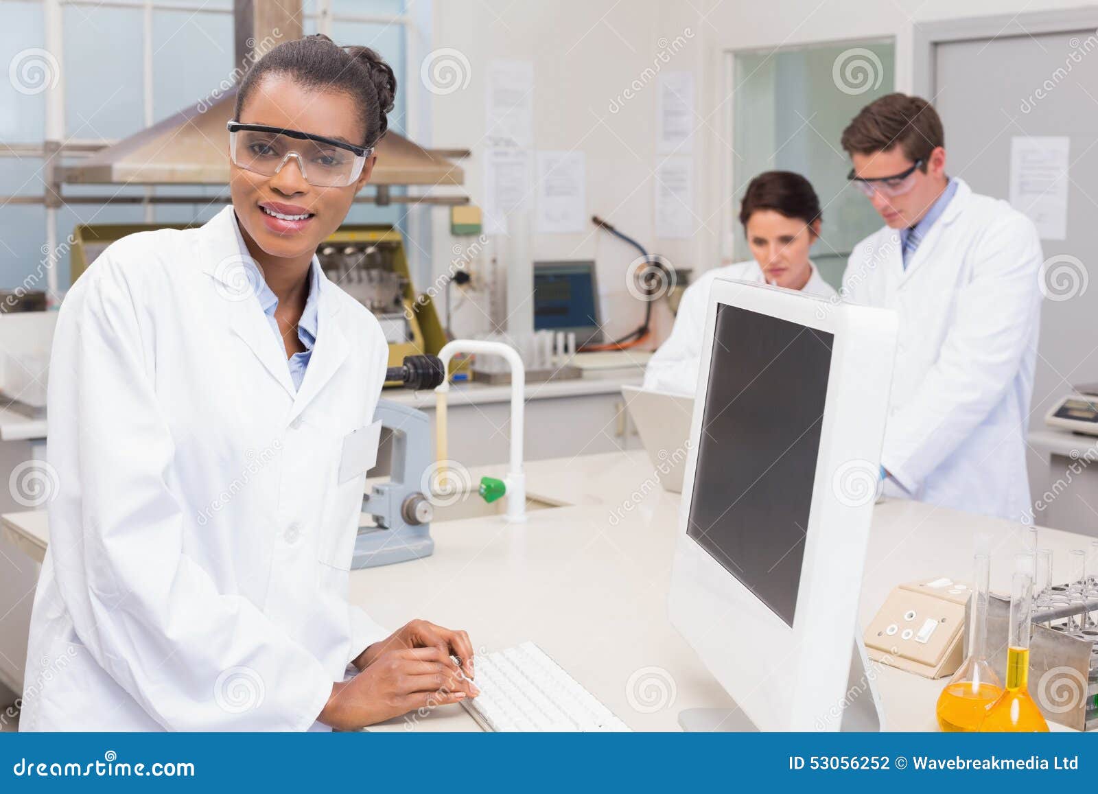 Happy Scientist Smiling at Camera while Colleagues Working Together ...