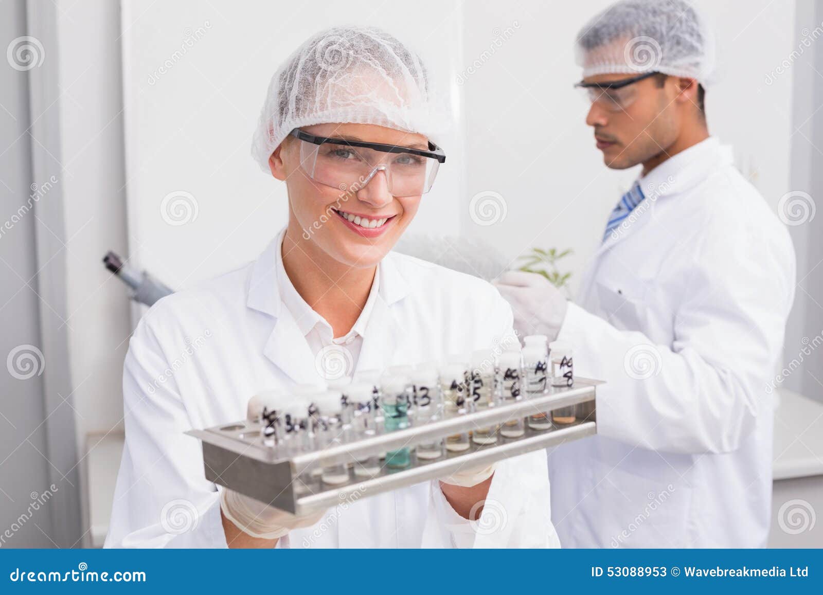 Happy Scientists In White Coats Working Together With Microscope In ...
