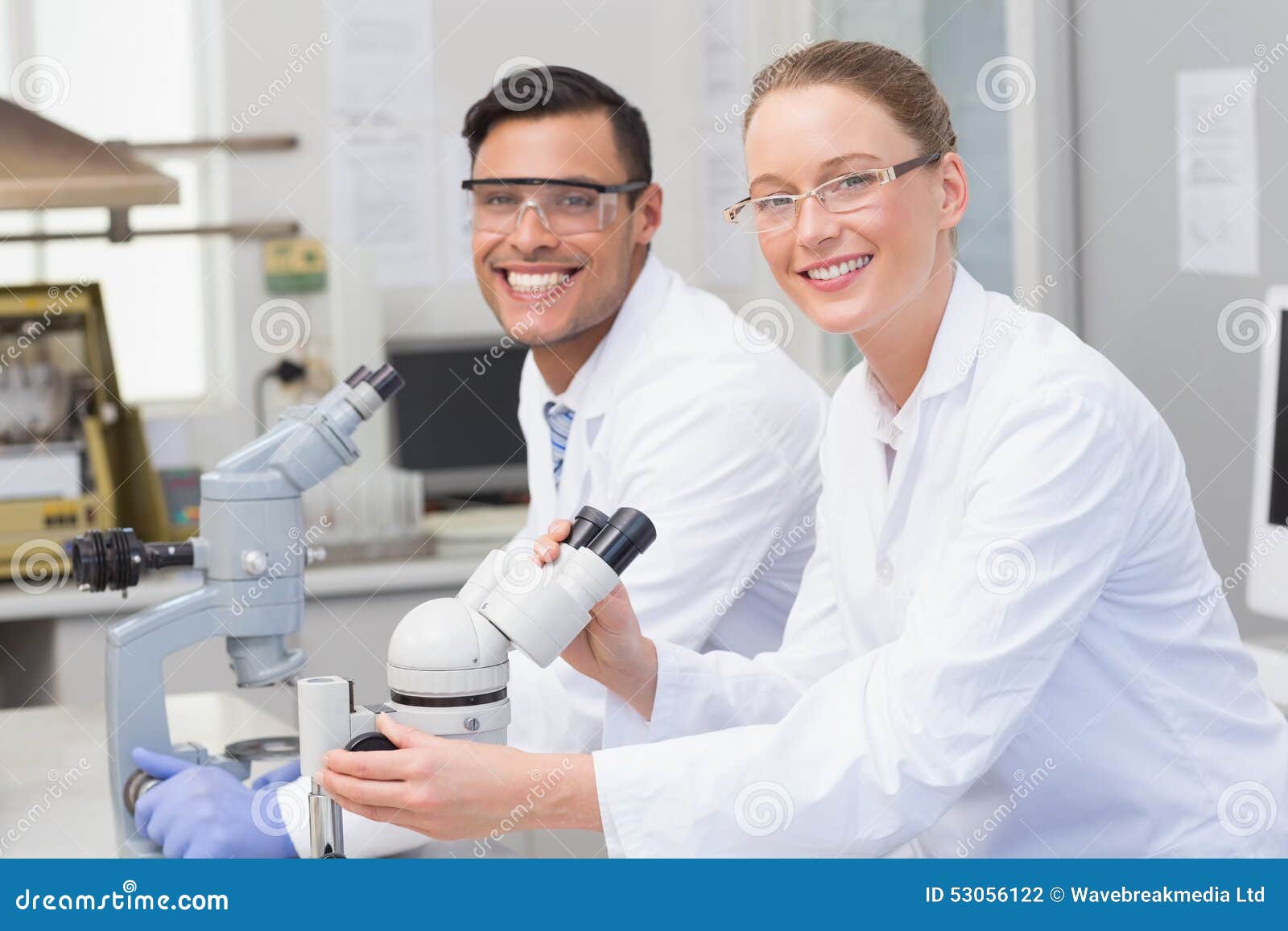 Happy Scientists Using Microscope Stock Photo - Image of microscope ...