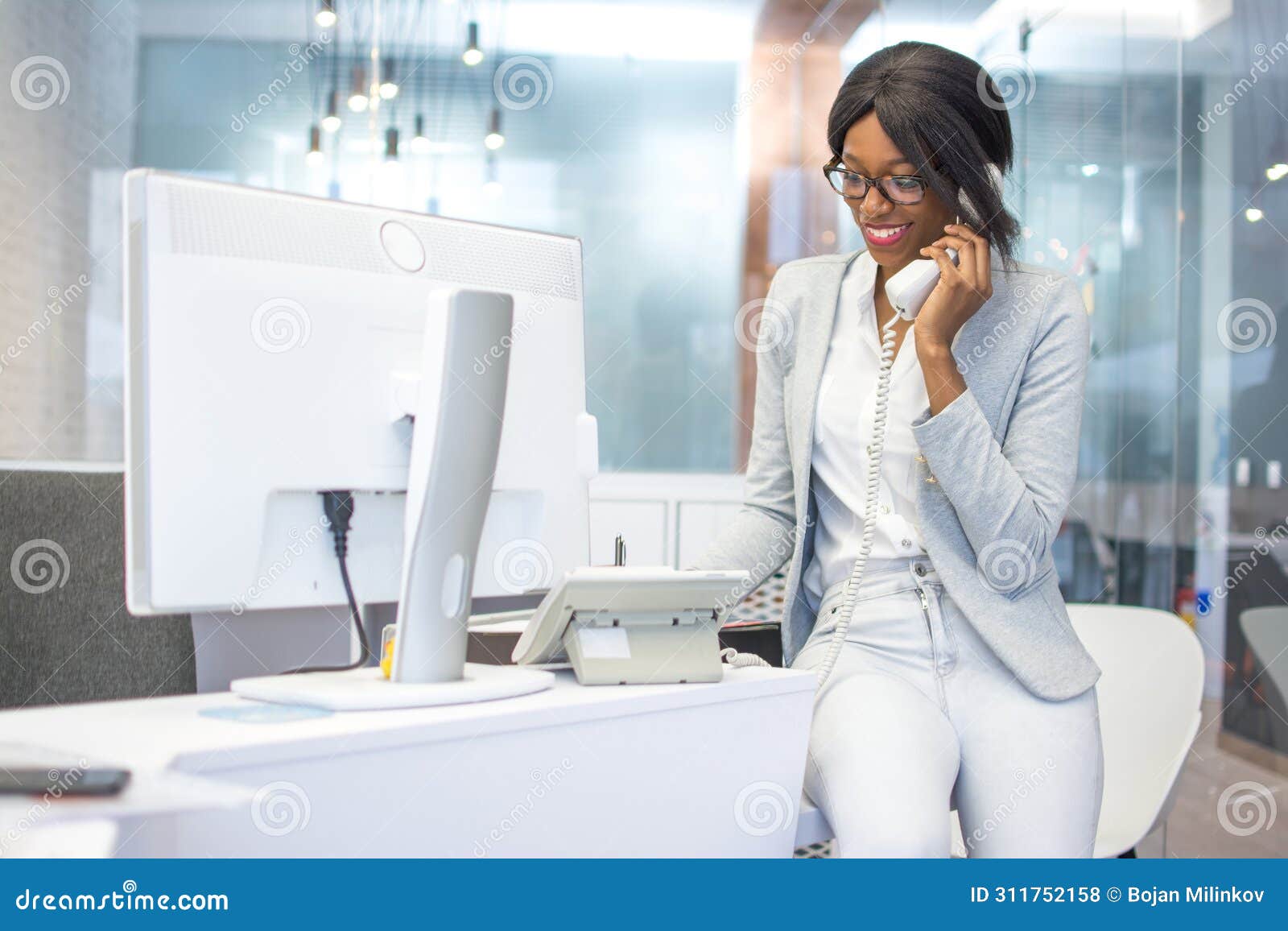 Happy Secretary Talking on the Phone in the Office. Stock Photo - Image ...