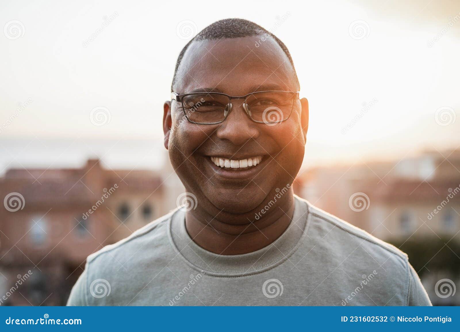 Happy Senior African Man Looking at Camera Outdoors at Sunset - Focus ...