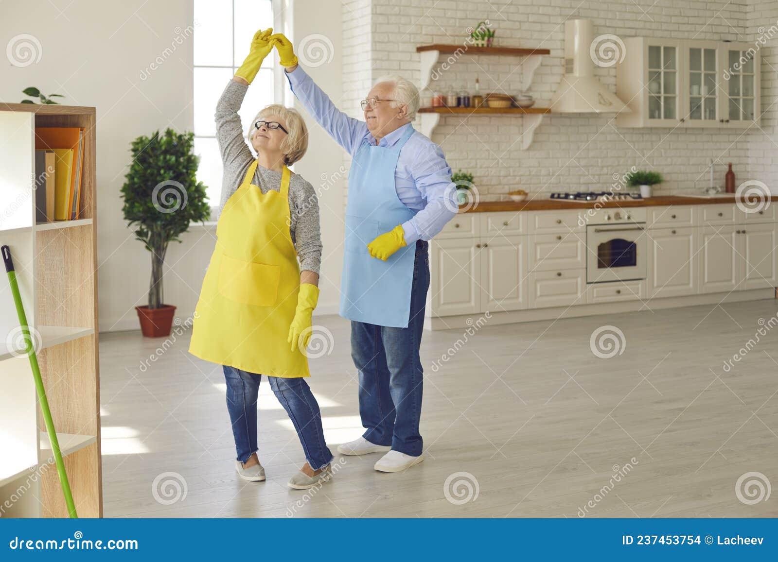 Happy Senior Couple Having Fun and Dancing while Tidying Up Their New ... Happy Senior Couple Having Fun and Dancing while Tidying Up Their New ...