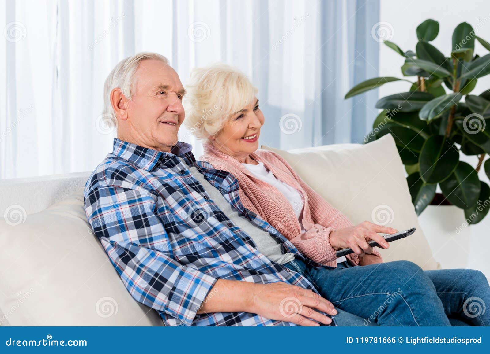 Happy Senior Couple with Remote Control Watching Tv Stock Photo - Image ...