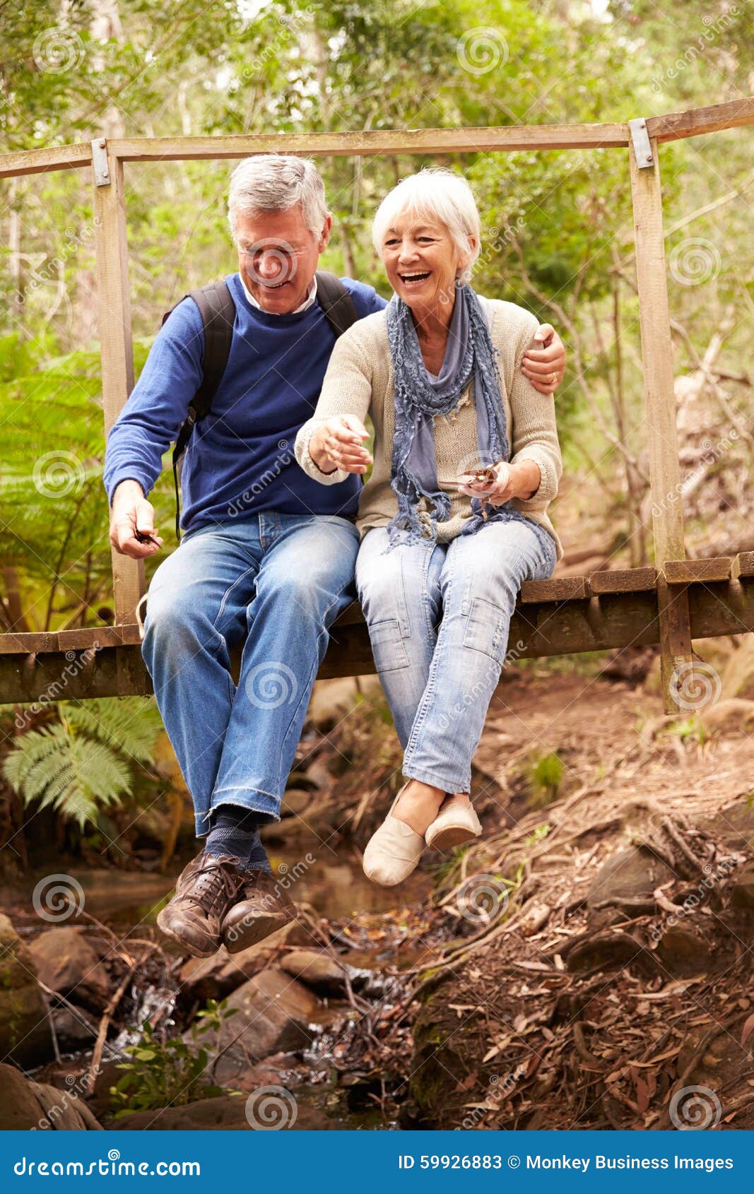Happy Senior Couple Sitting on a Bridge in Forest, Vertical Stock Image ...