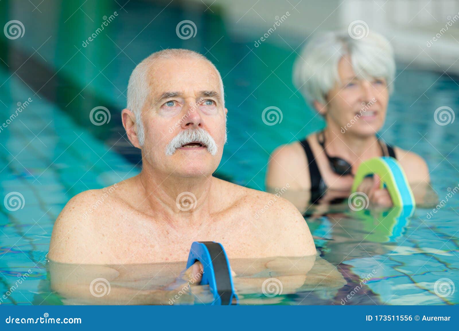 Happy Senior Couple Swimming in Pool Stock Photo - Image of pool ...