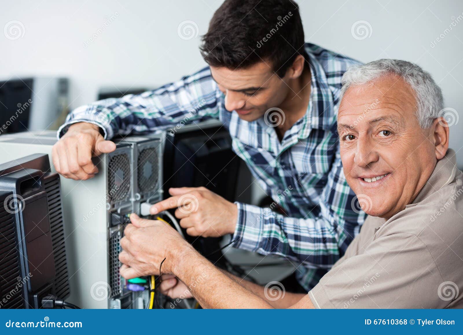 Happy Senior Man with Teacher Installing Computer in Classroom Stock ...