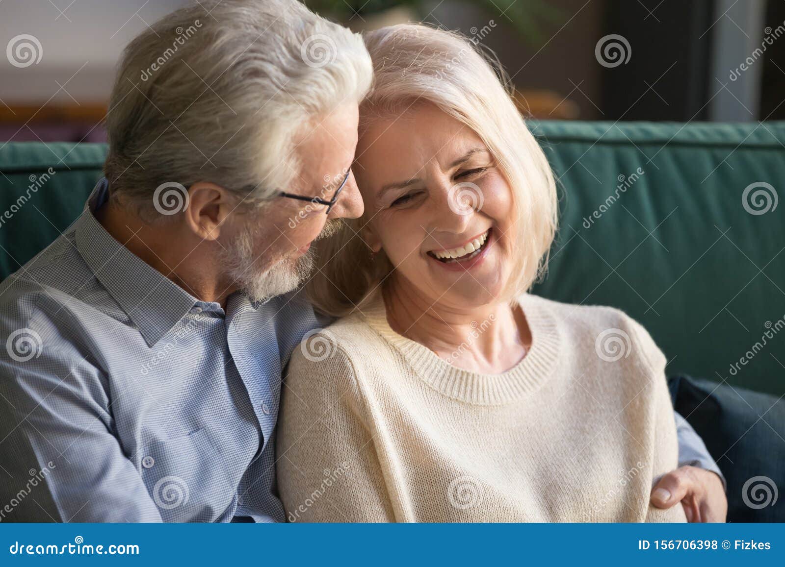 Happy Senior Old Couple Bonding Talking Embracing Laughing At Home