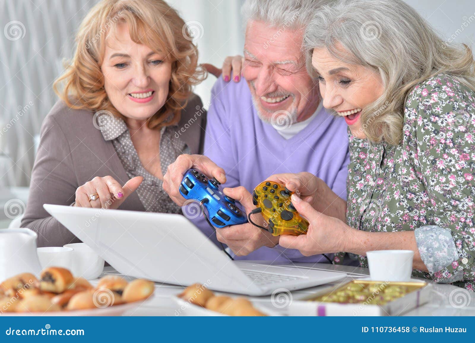 Senior People Playing Computer Game with Laptop while Drinking T Stock ...