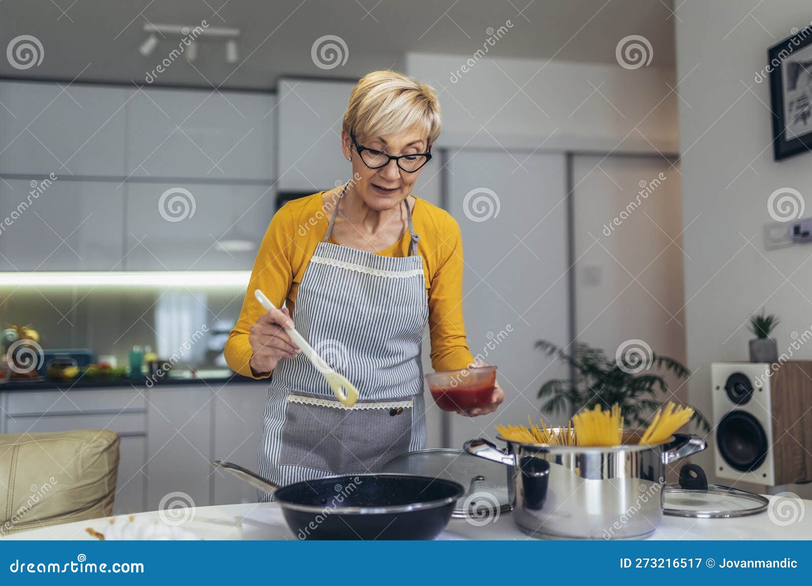 Senior Woman Cooking in Her Modern Kitchen Stock Image - Image of ...