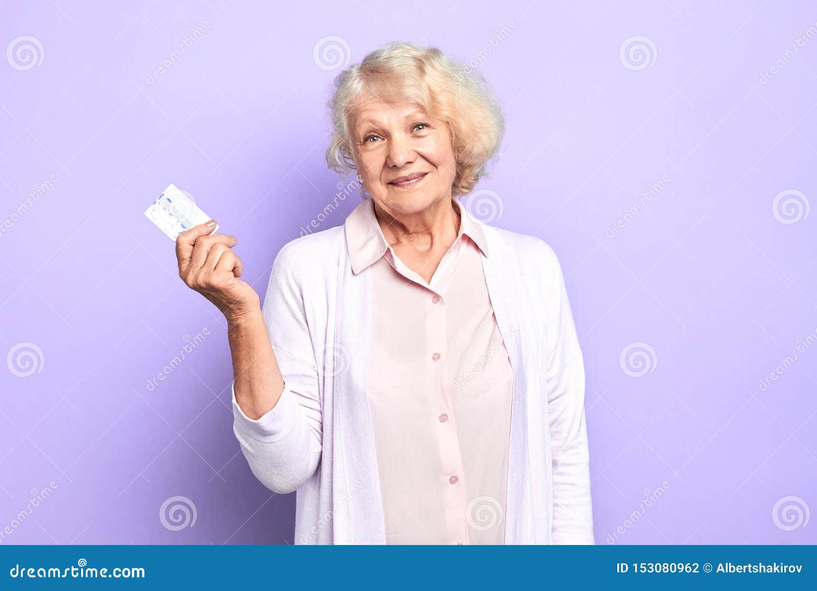Happy Senior Woman Holding Credit Card on Hand Smiling and Looking at ... Happy Senior Woman Holding Credit Card on Hand Smiling and Looking at ...