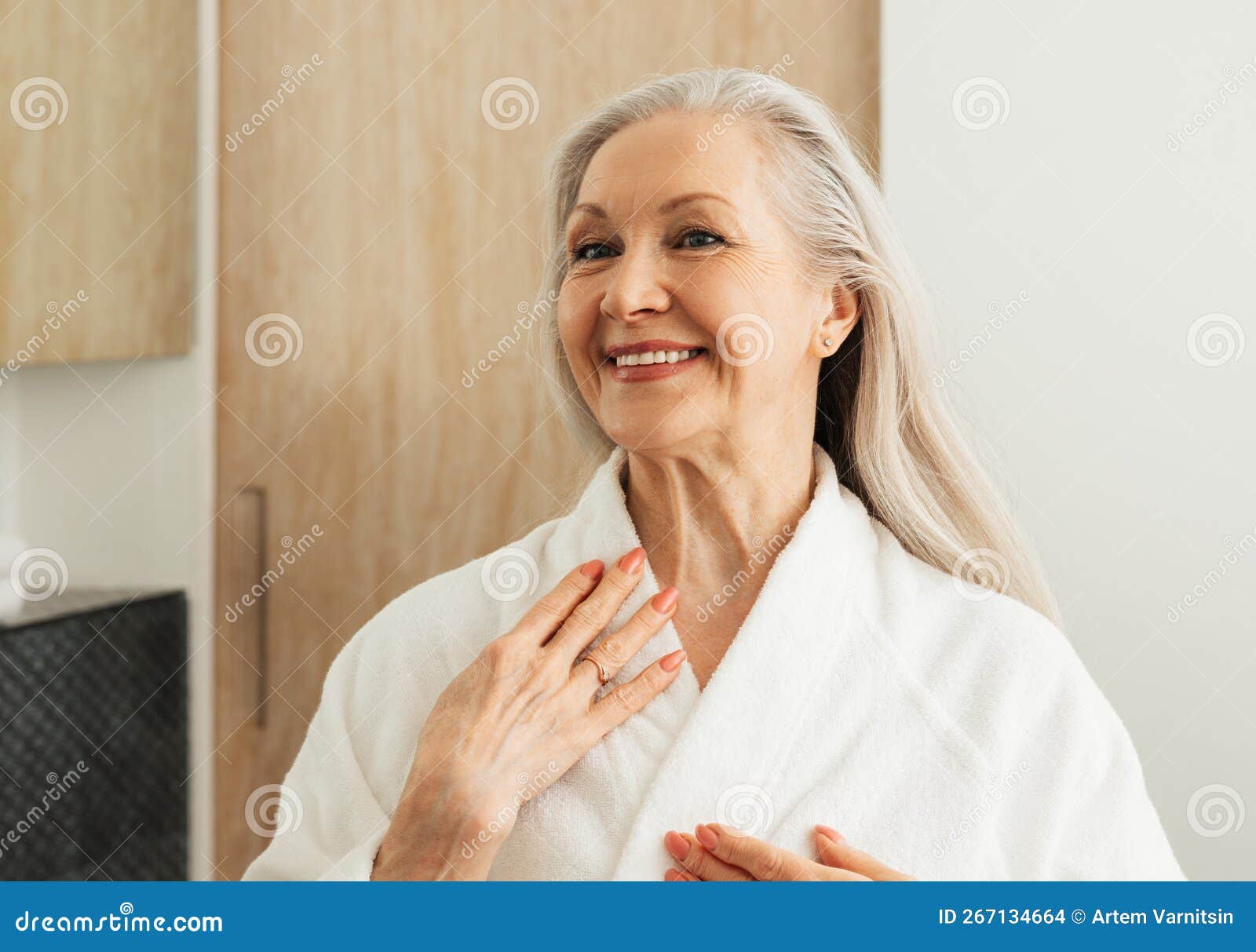 Happy Senior Woman Looking at Her Reflection in the Mirror in Morning ... Happy Senior Woman Looking at Her Reflection in the Mirror in Morning ...