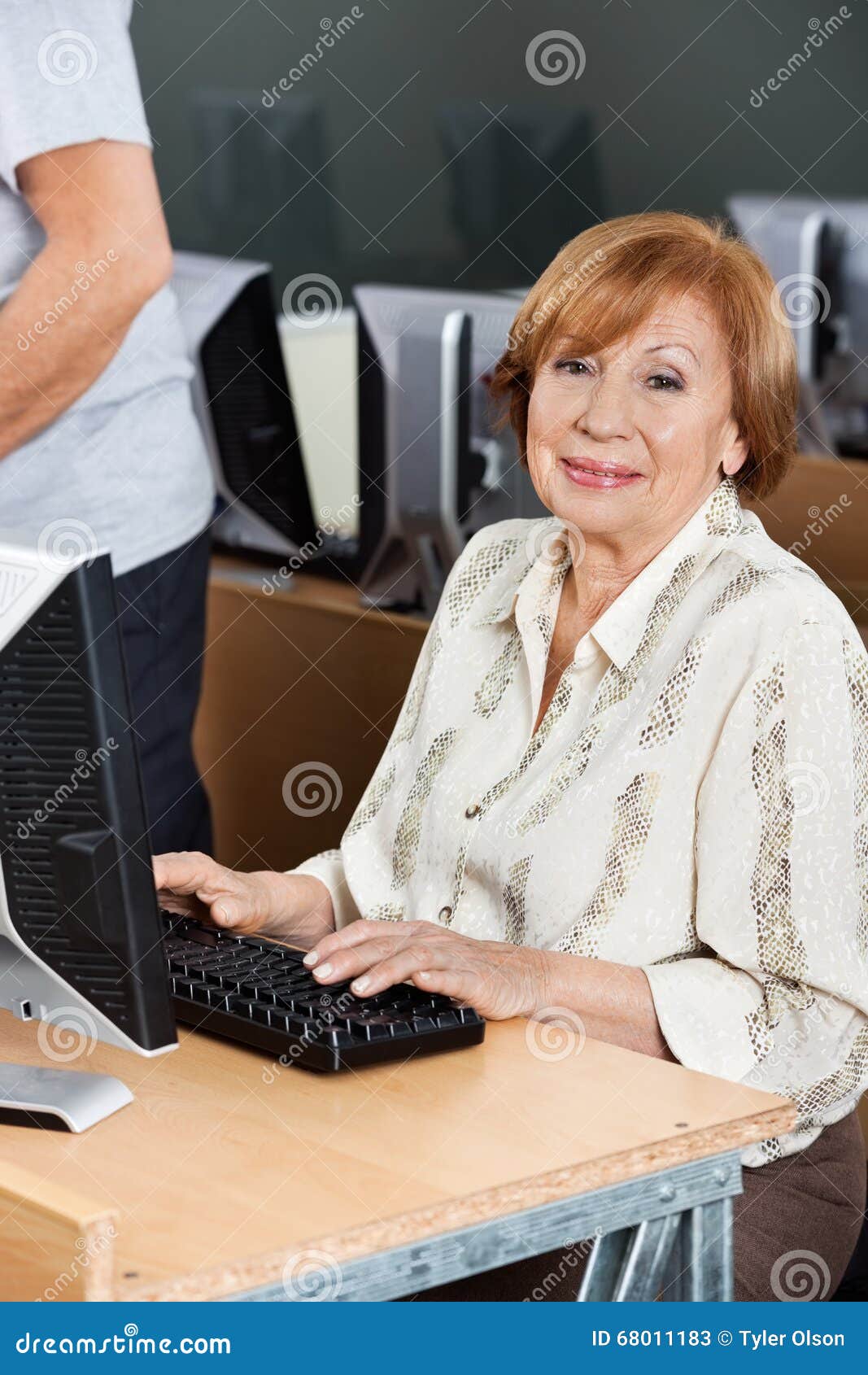 Happy Senior Woman Using Computer at Desk in Classroom Stock Image ...